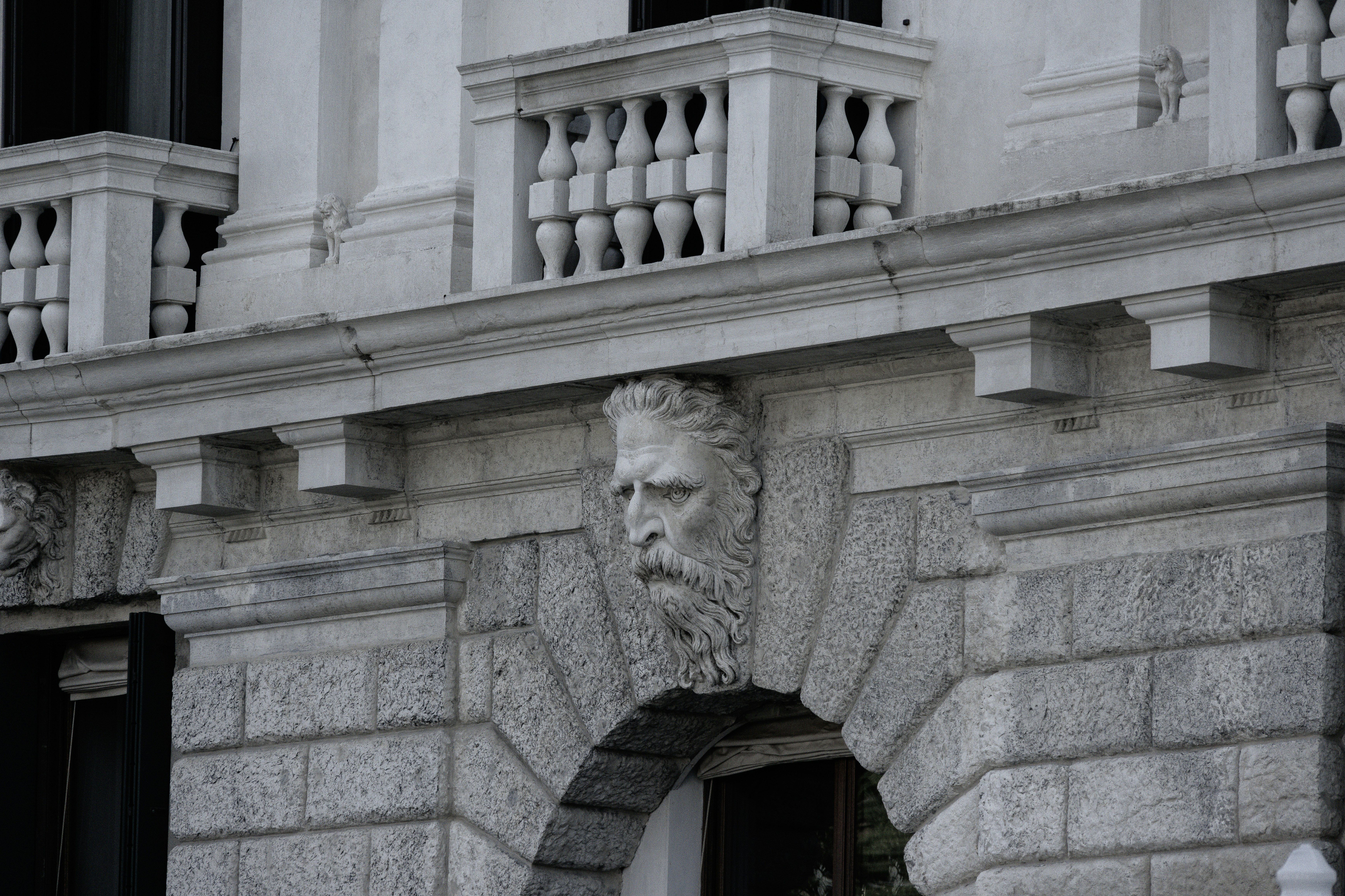 Stone Bearded Sentinel Over the Arched Entrance