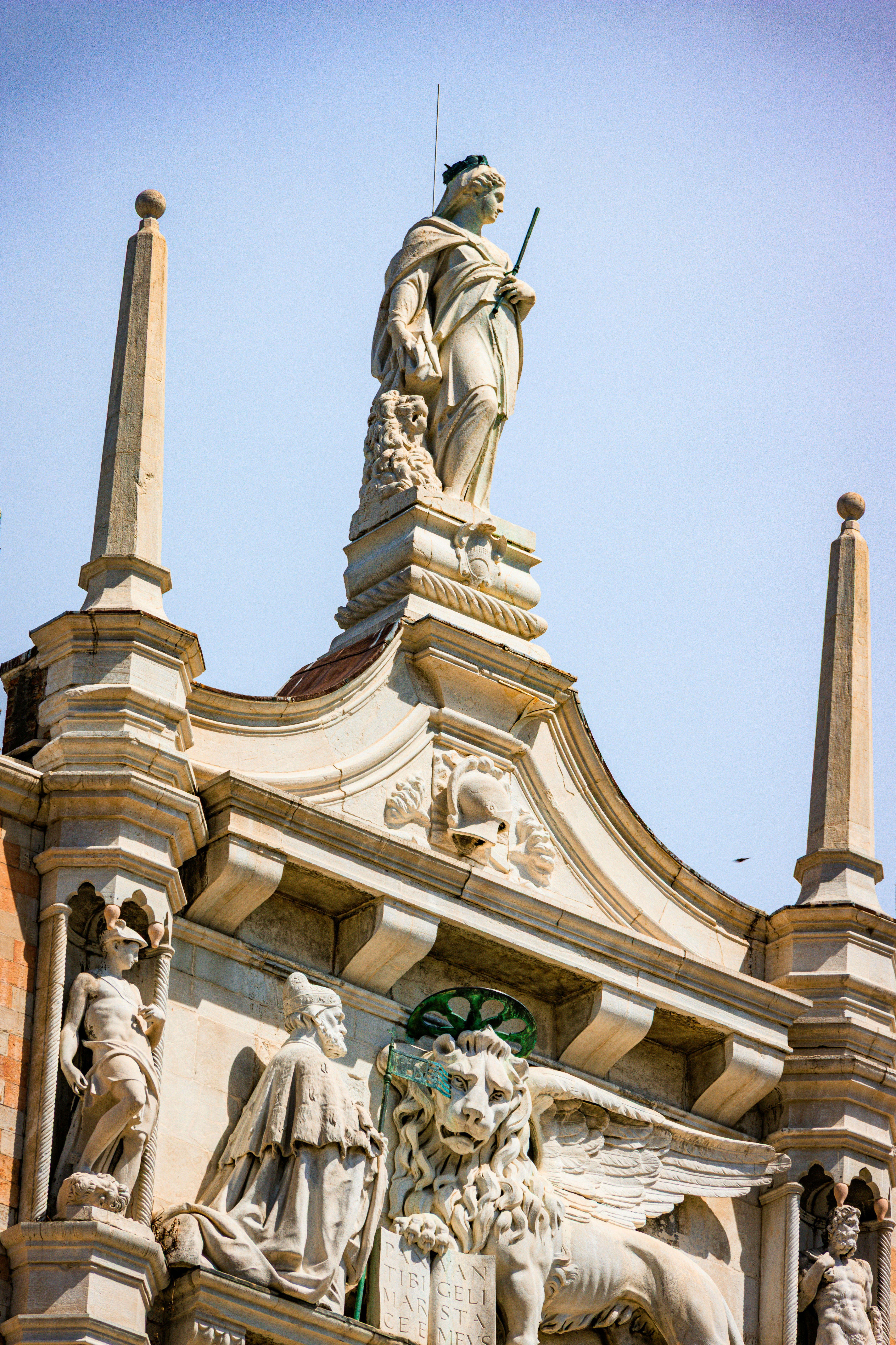 Statue of Graceful Sentinel atop an Ornate Pediment