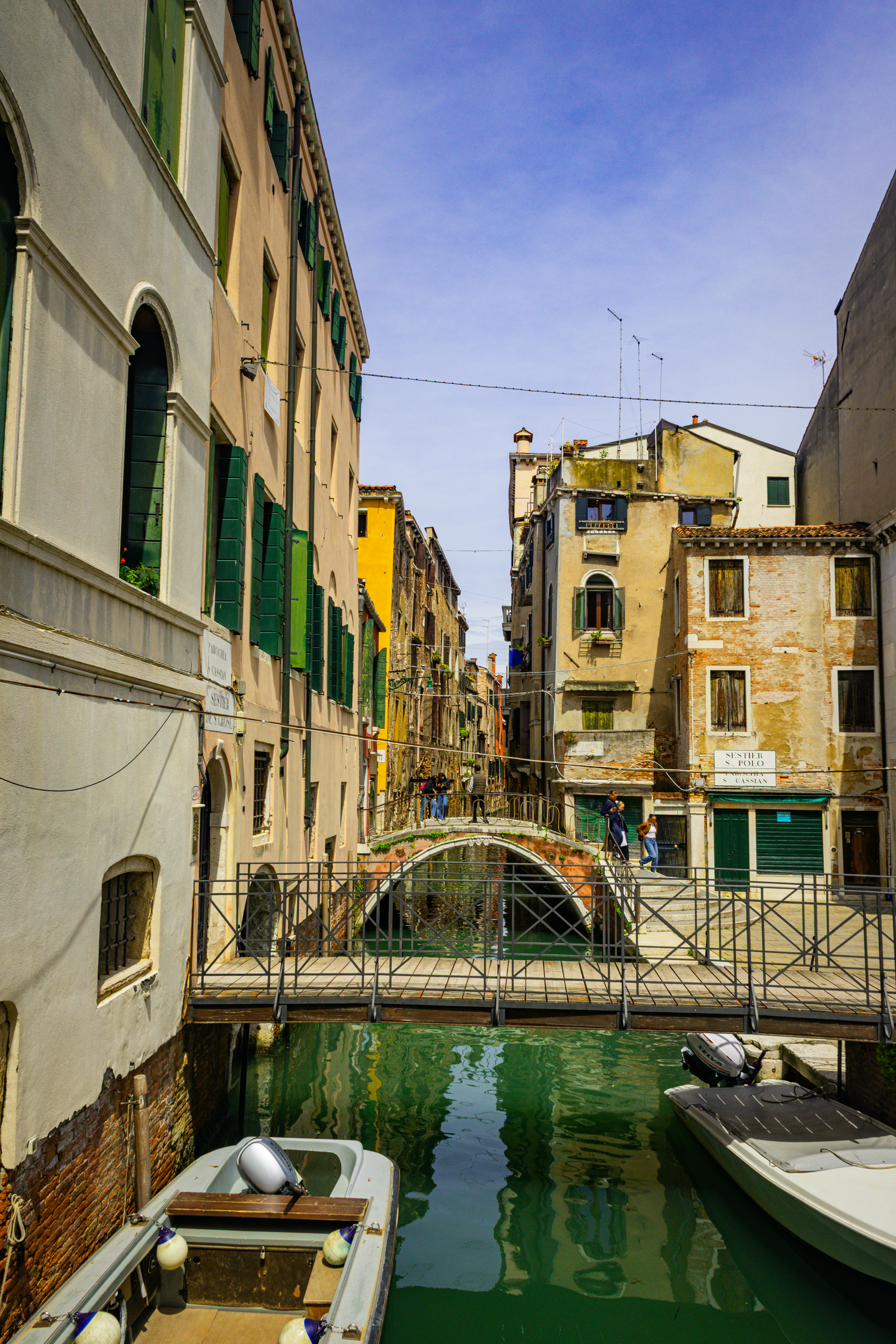 Colorful Canal Crossing: A Quiet Venetian-Style Street Framed by Riverside Balconies