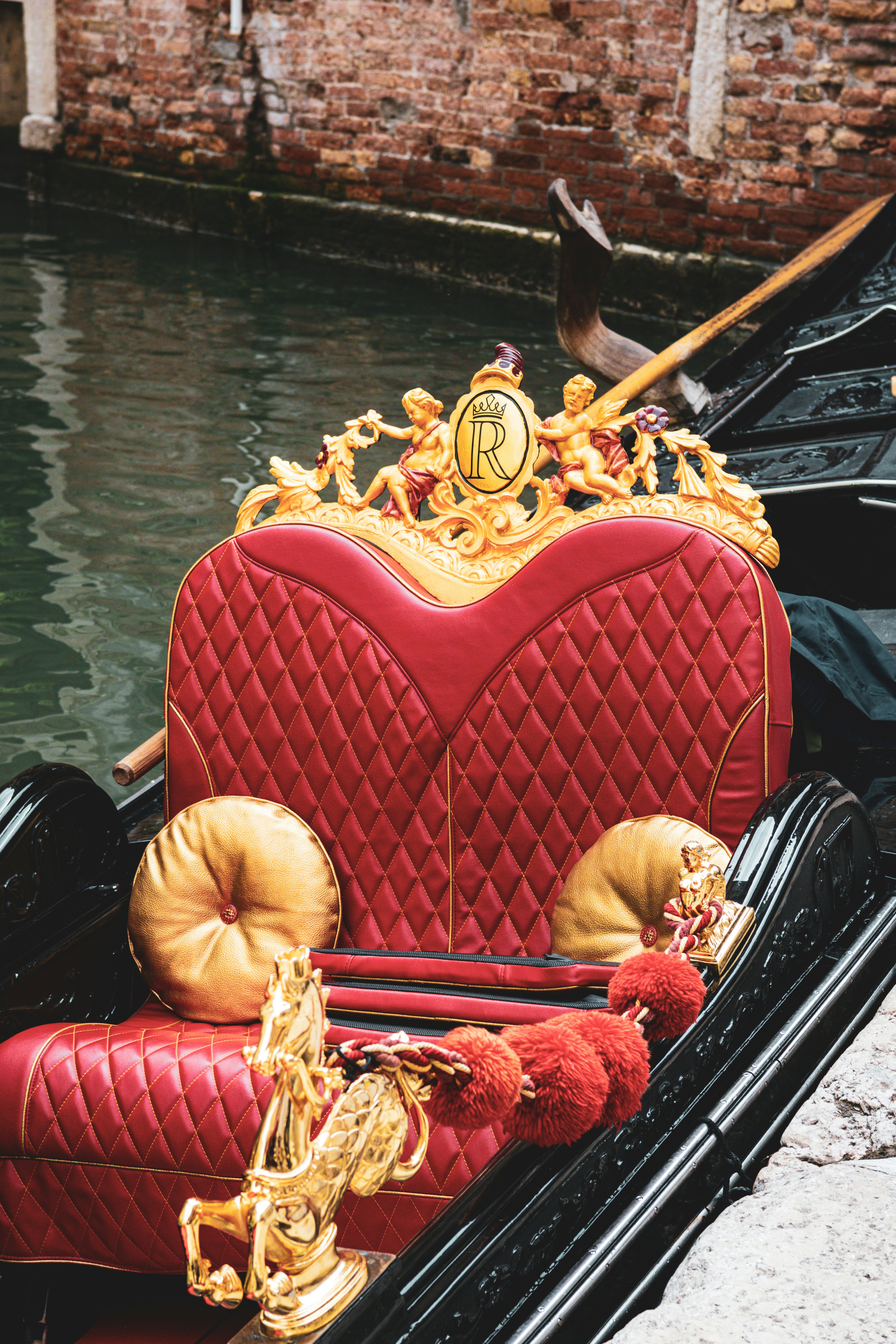 Regal Venetian Chair: Gold Crest and Plush Red Carriage Seat