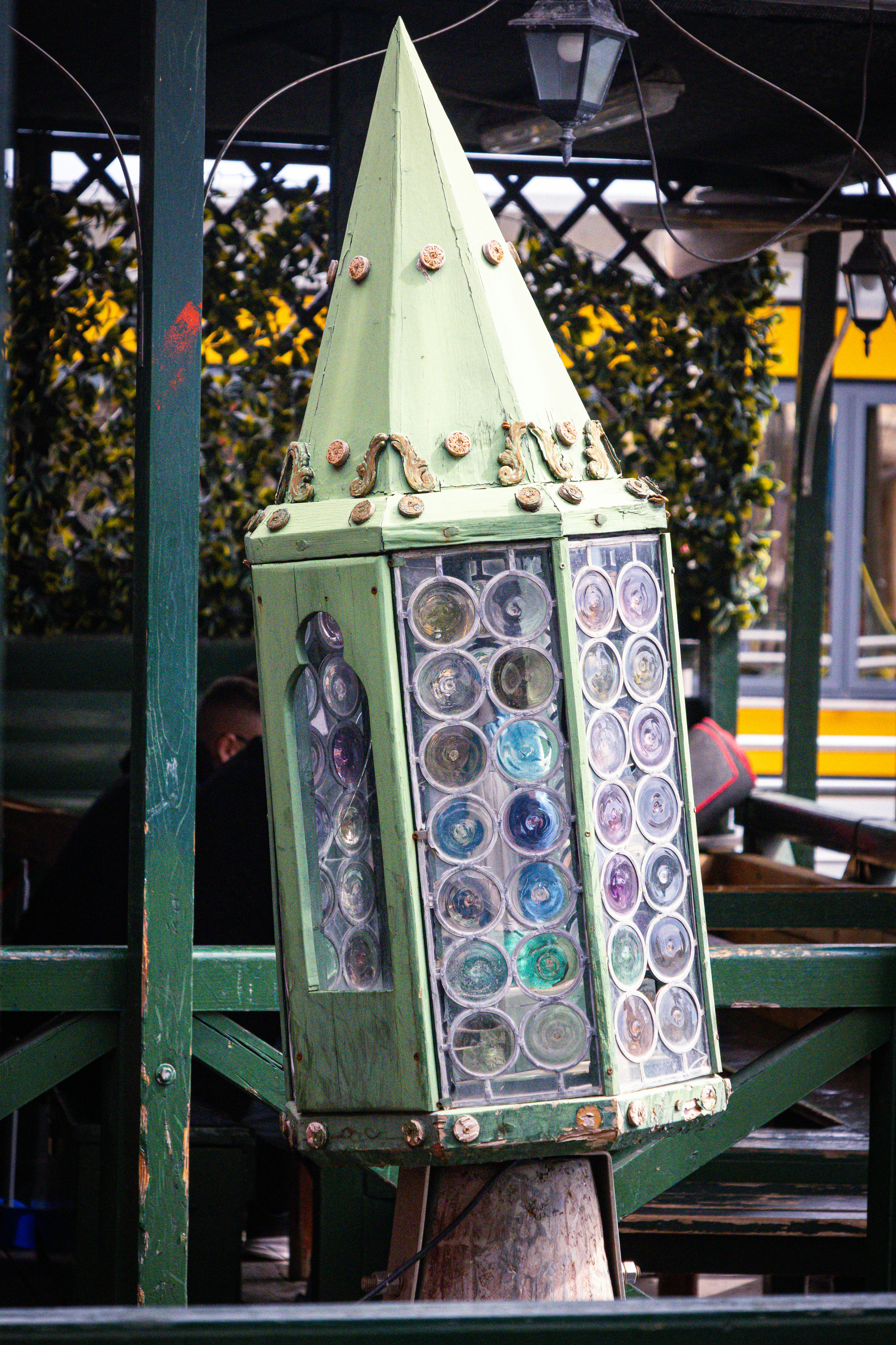 Green Victorian Lantern with Glass Dial Panels at a Market Stall