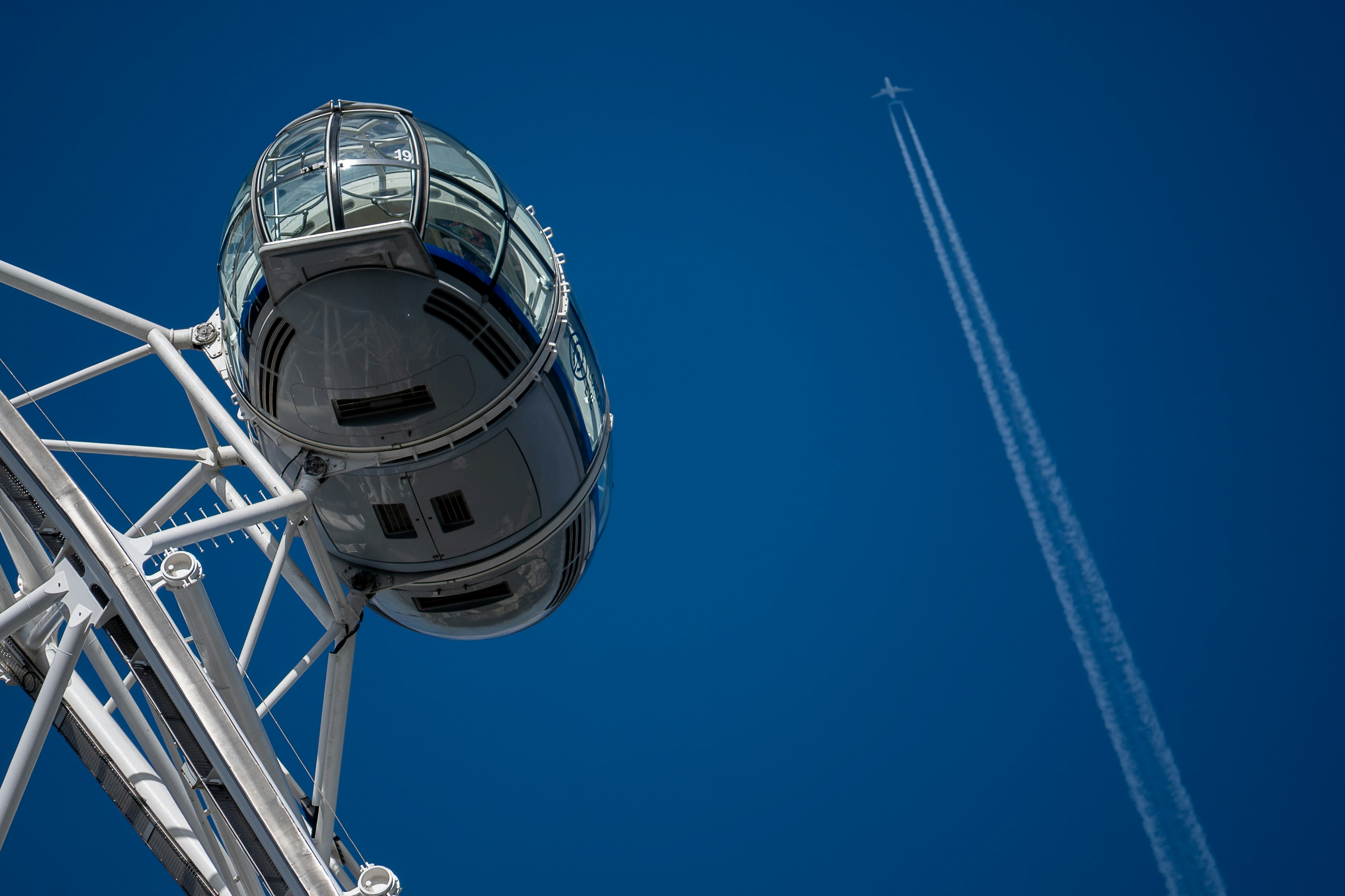 Orbiting View: The Glass Capsule Against a Cerulean Sky