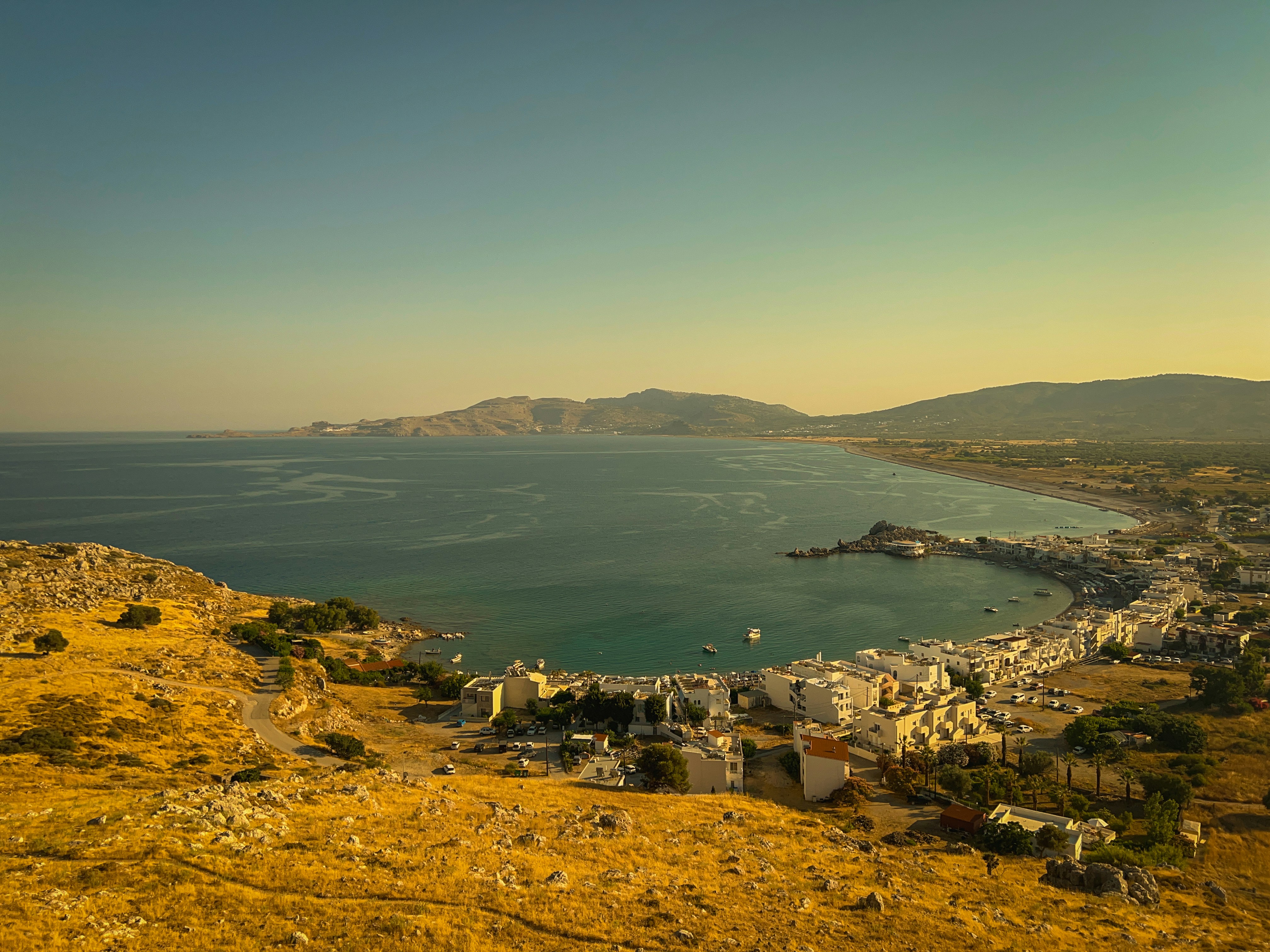 Sunlit Cape Panorama: Quiet Town by the Blue Sea
