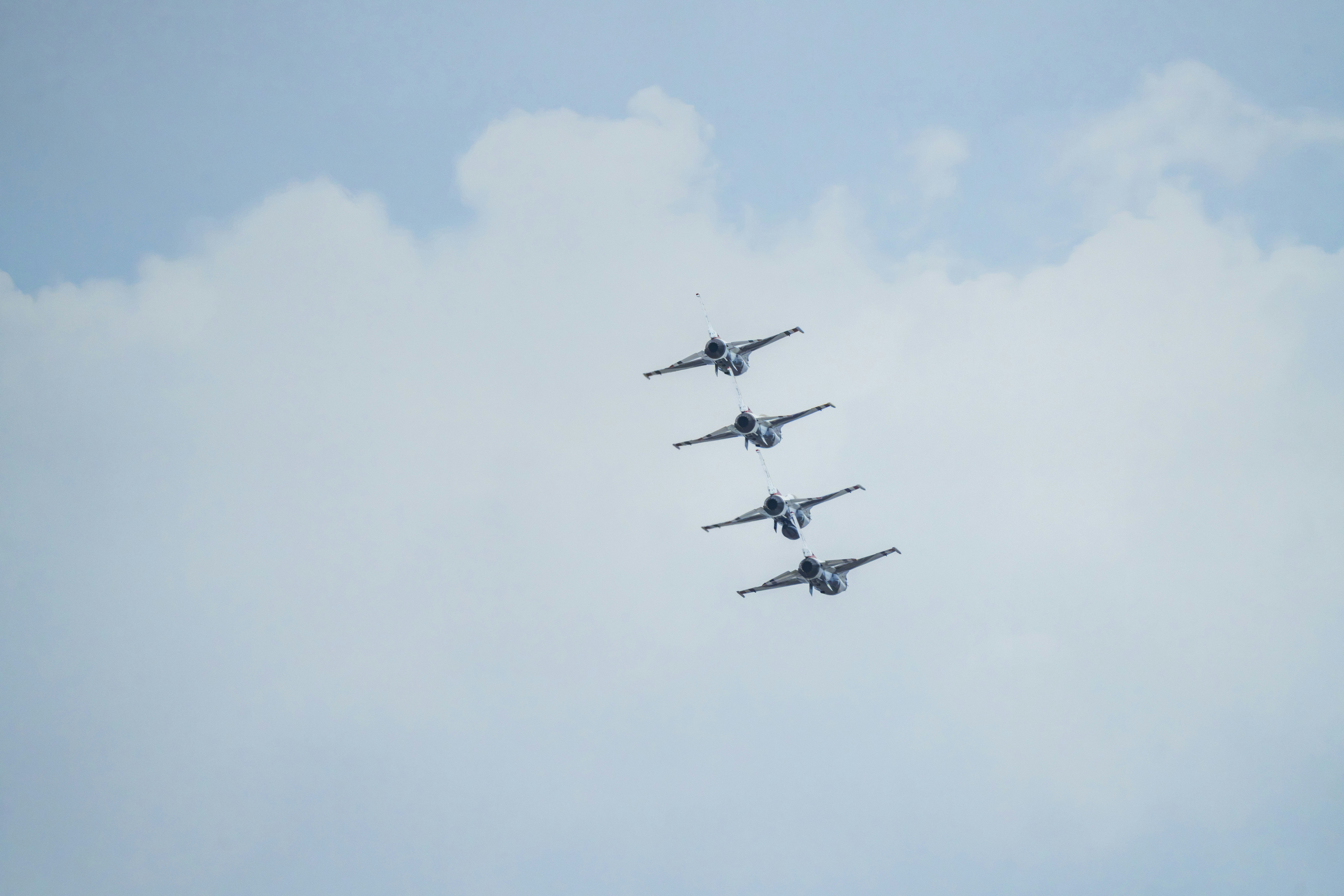 Formation of Four Aircraft Piercing a Pale Sky