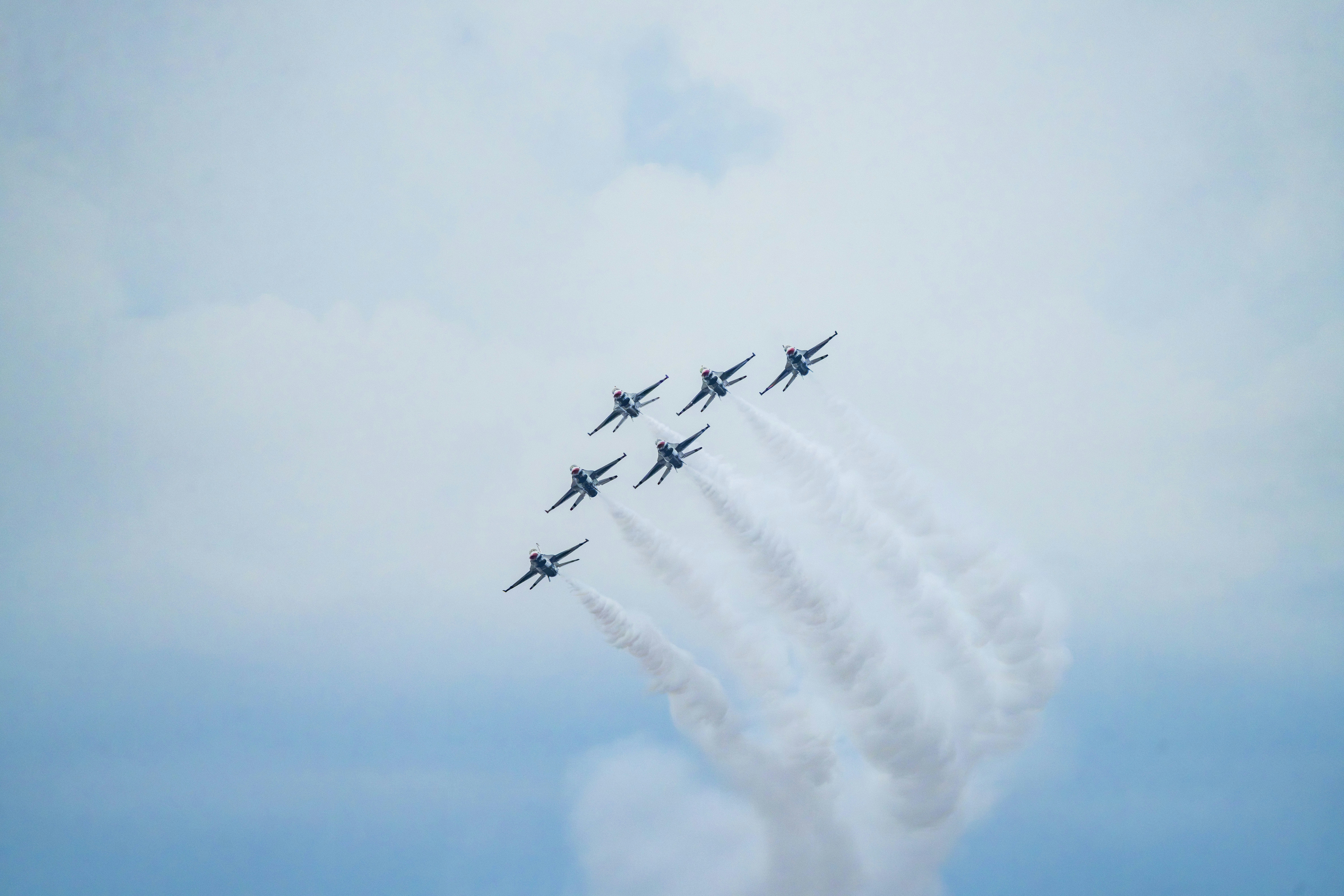 Six-jet Formation Arrow: Smoke Trails Against a Sky-Blue Canvas