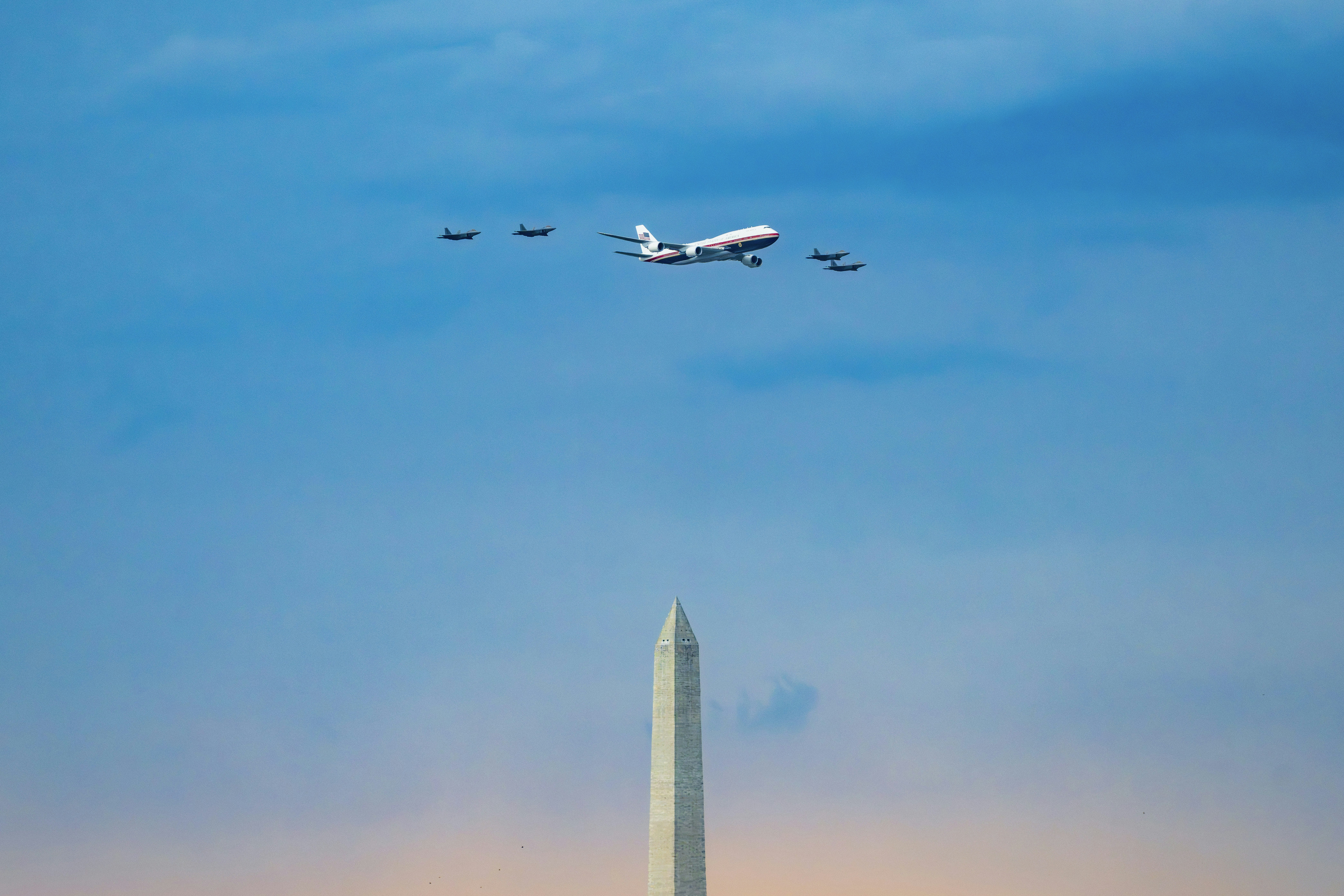 Trio of Jets and a Passenger Plane Crossing the Sky Above the Monument