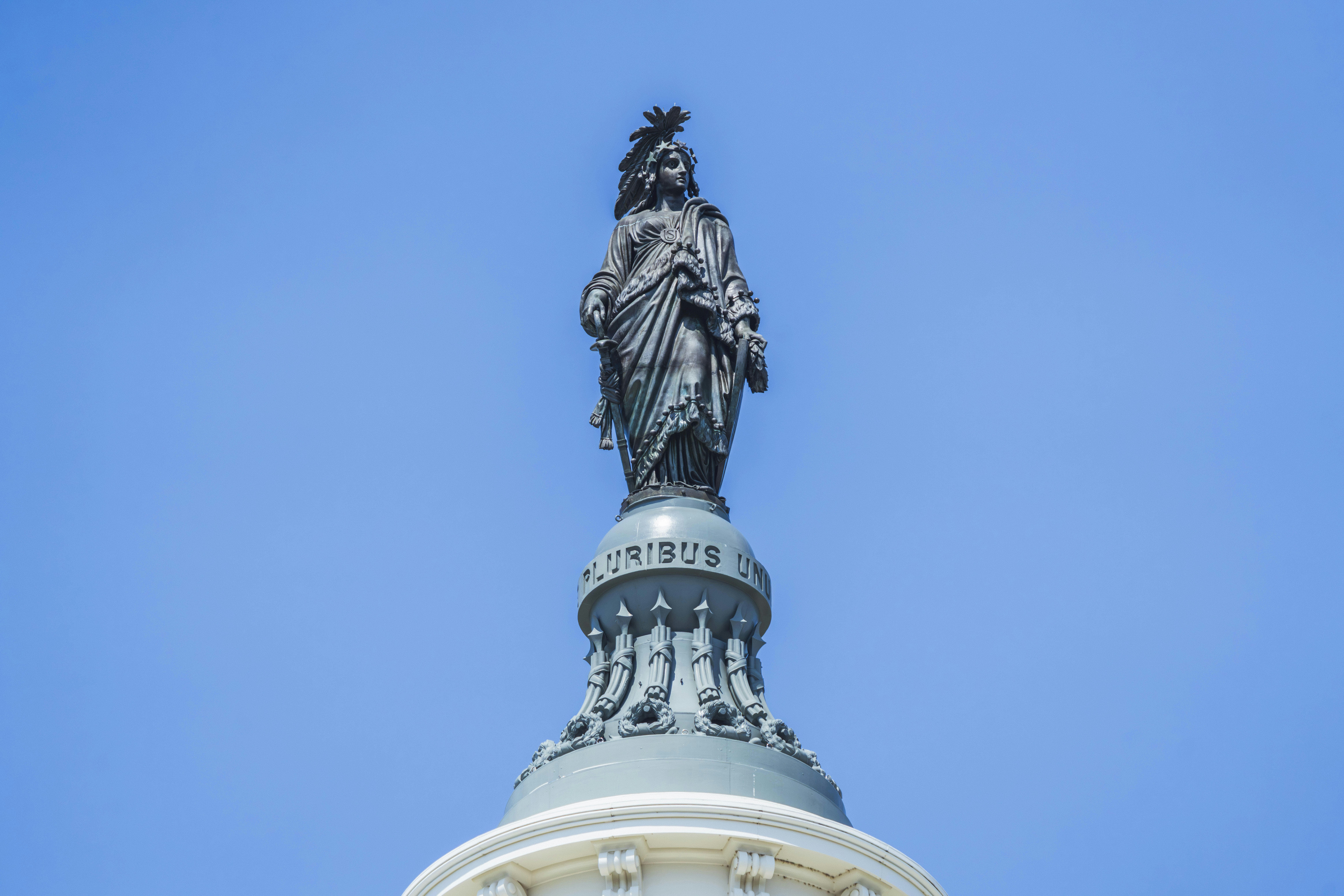 Statue Crowned in Blue: A Distant View from the Pedestal
