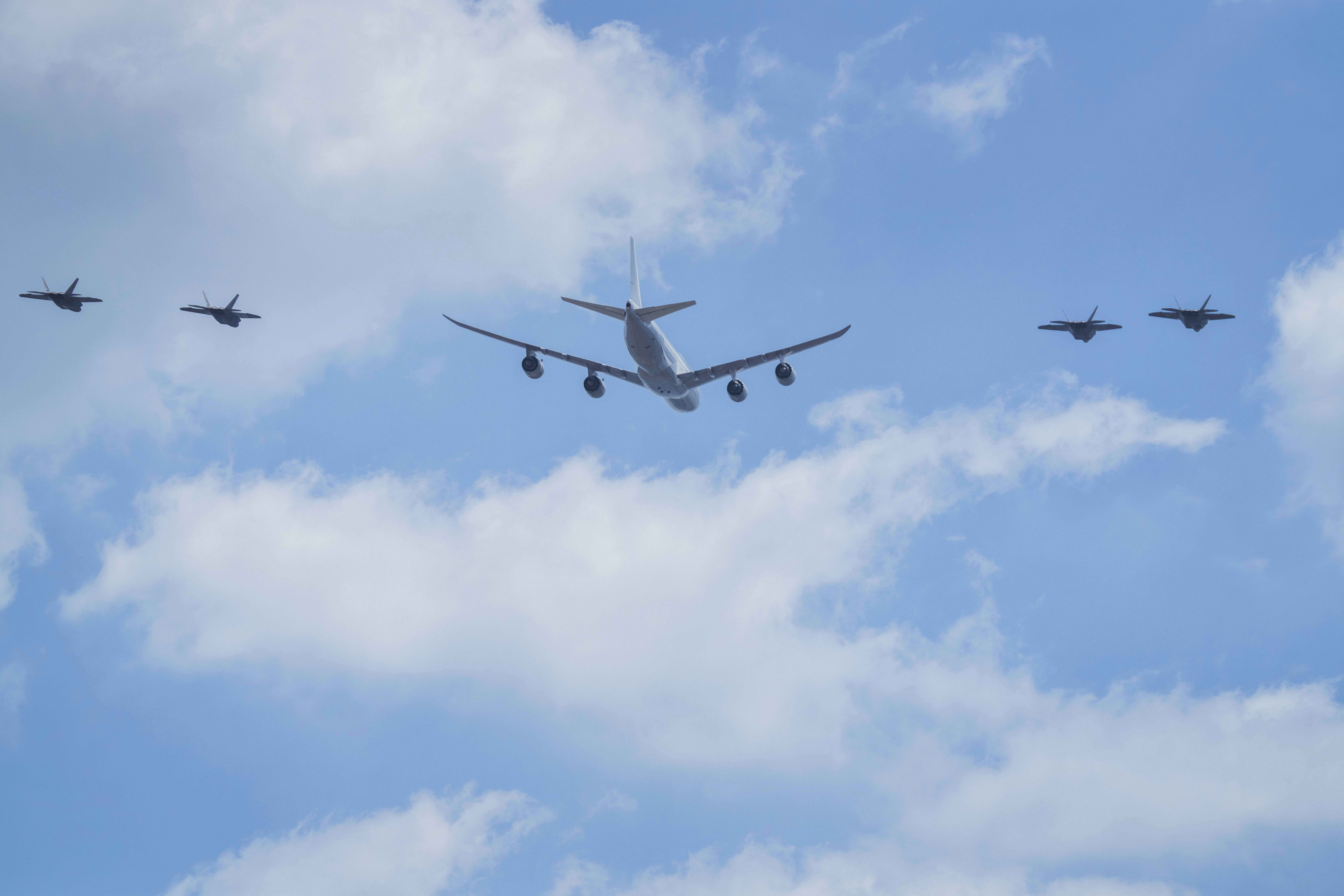 Mid-Flight V-formation: A Transport Jet in a Bright Sky