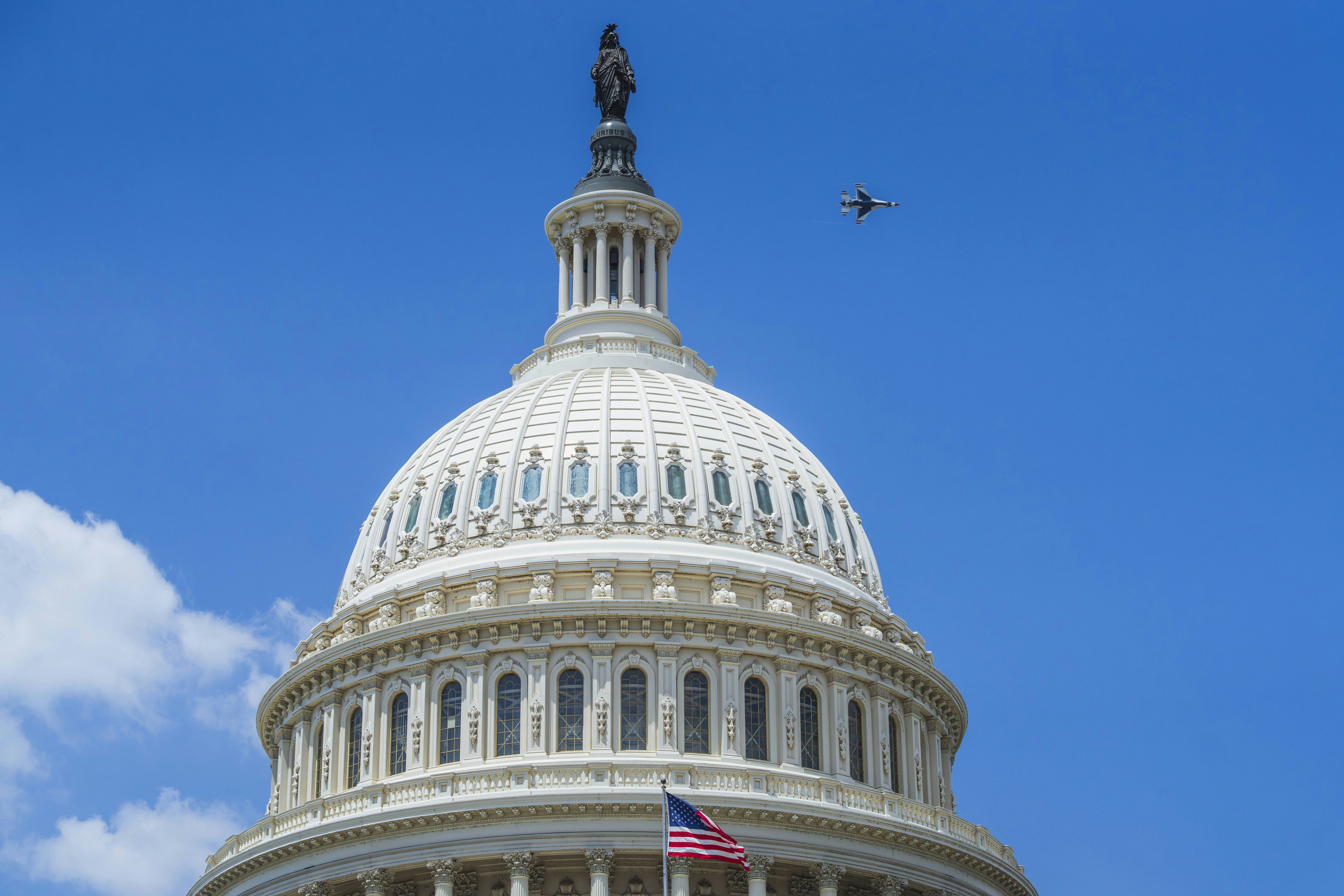 Capitol Dome in a Clear Blue Sky with an Elevating Aircraft