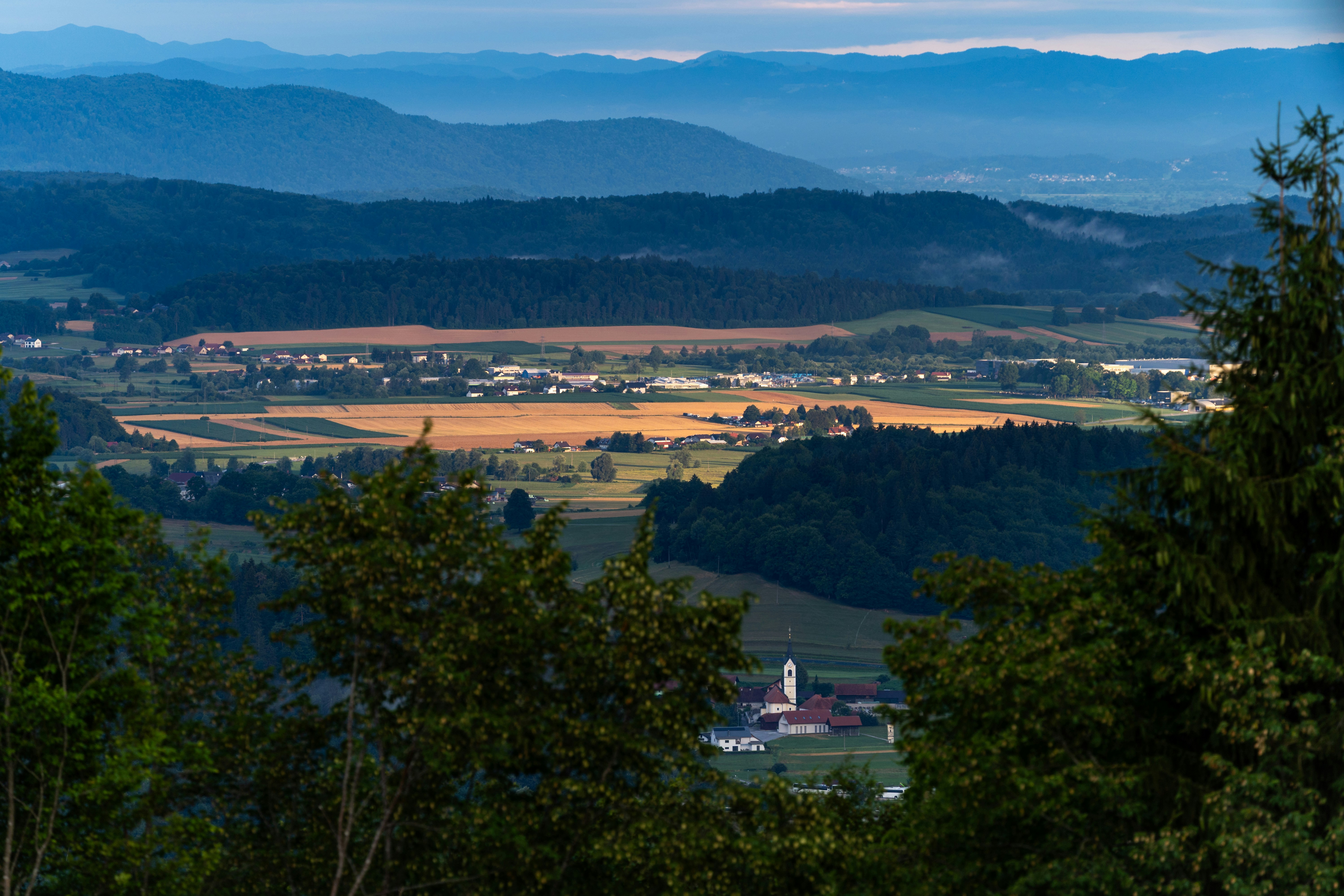 Farmland Village Nestled in Rolling Valleys at Dusk