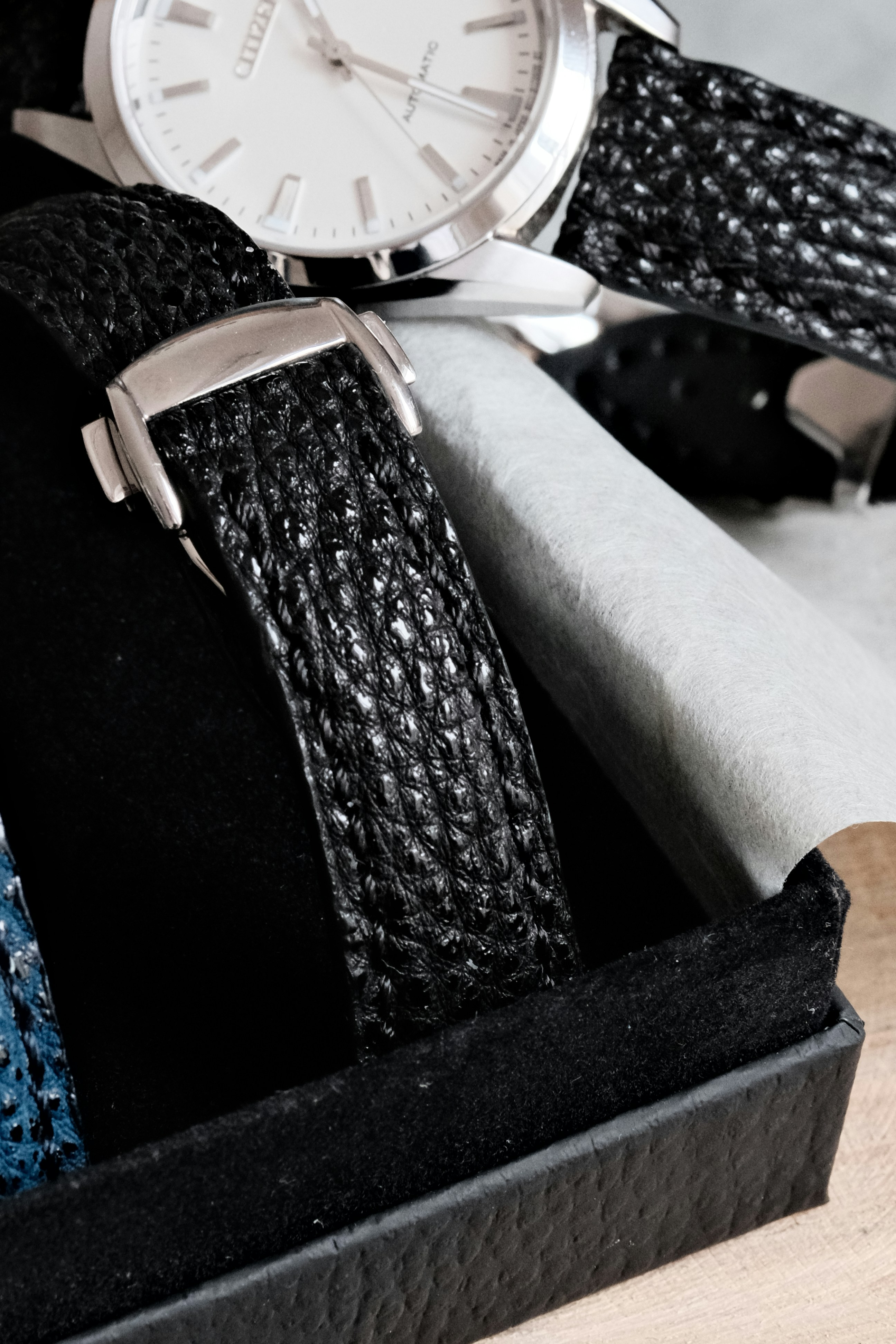 Tangled Time: A Close-Up of Leather Straps and a White-Washed Dial