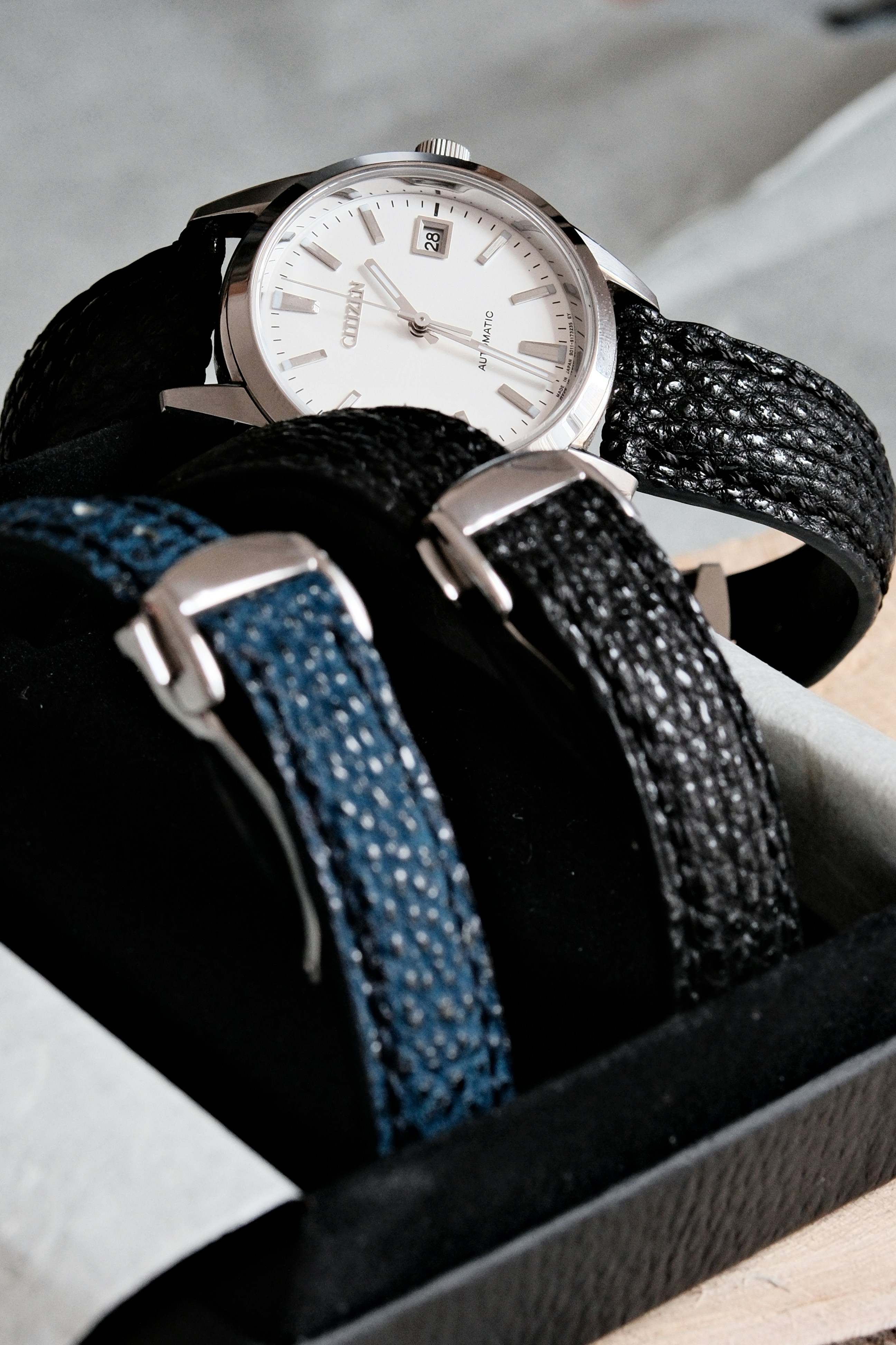 Timekeeper in Straps: A Close-Up of Metallic Texture and Leather Weave