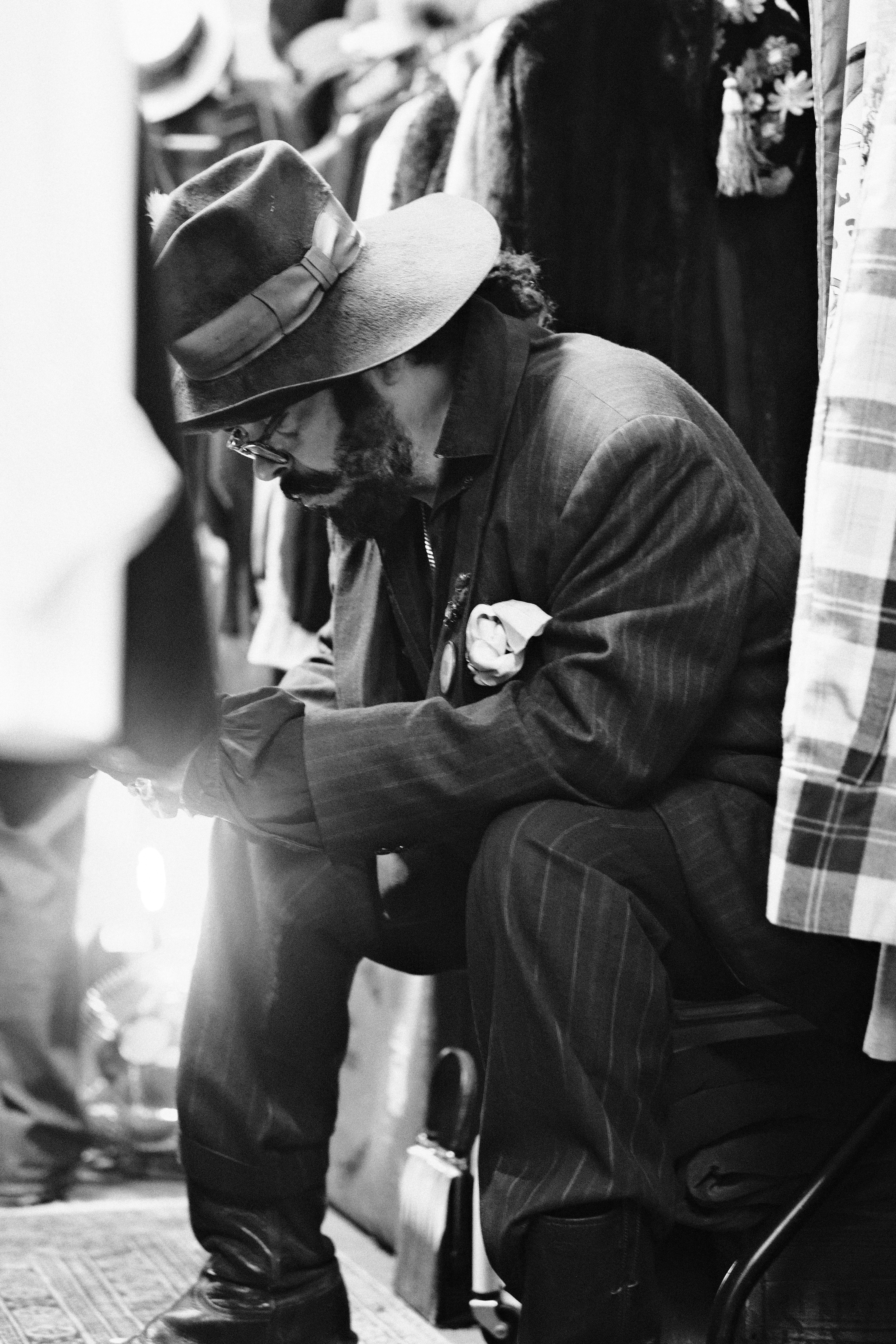 Gentleman in a Vintage Moment: A Quiet Pose among Cloth and Light