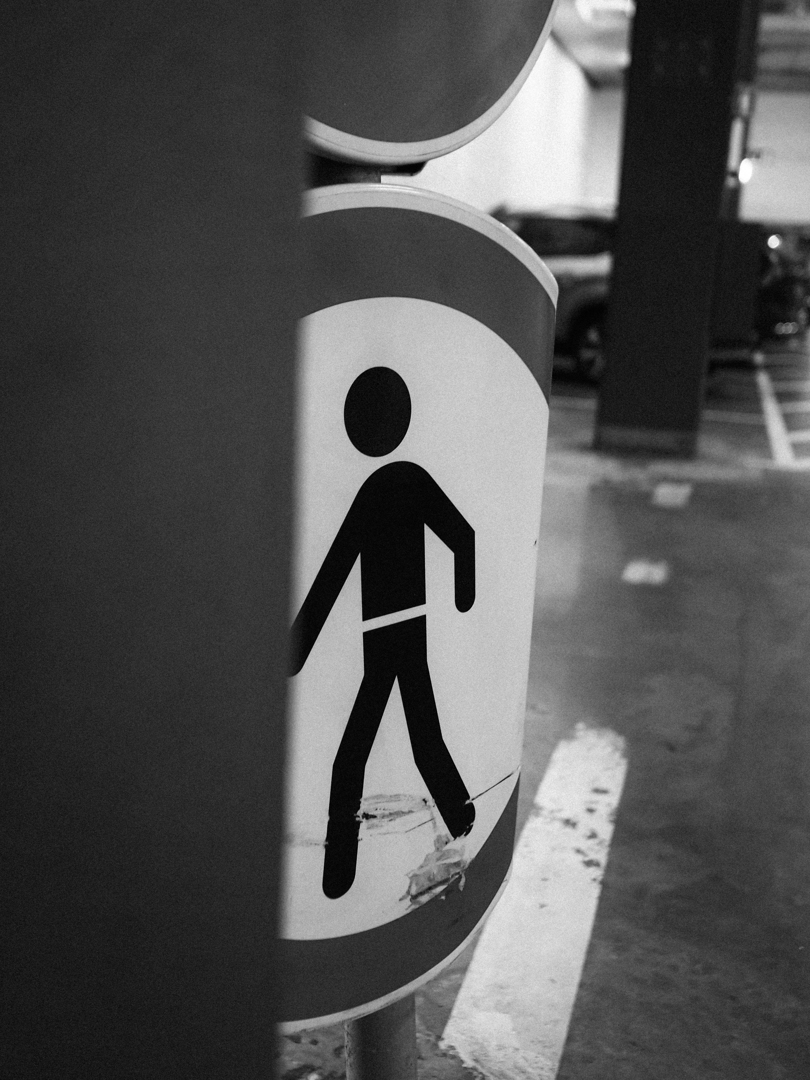 Leaned Signage: A Walk Past a Striped Parking Lot Boundary
