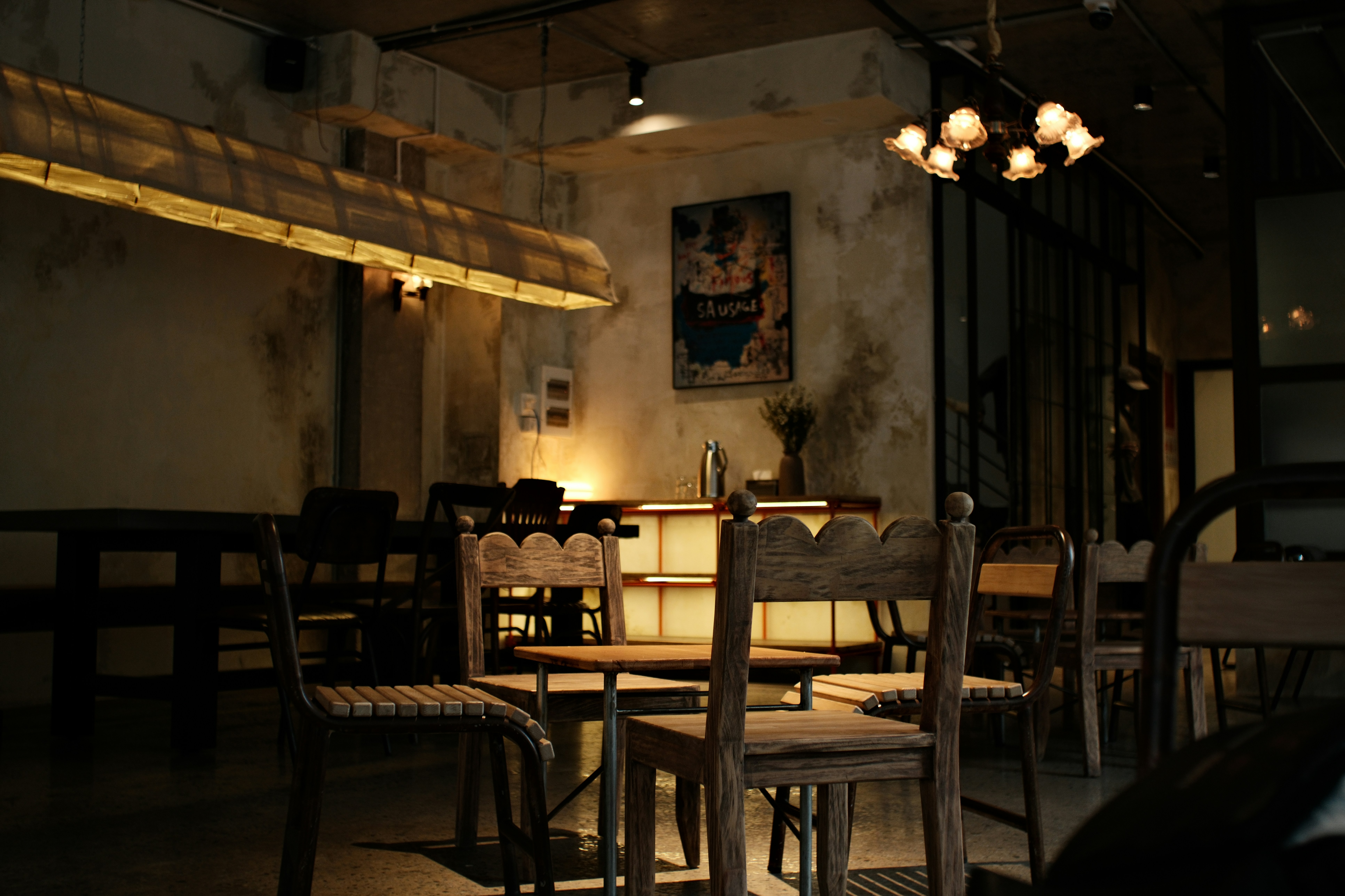 Quiet Café Afterglow: Wooden Chairs in Dappled Bar Light