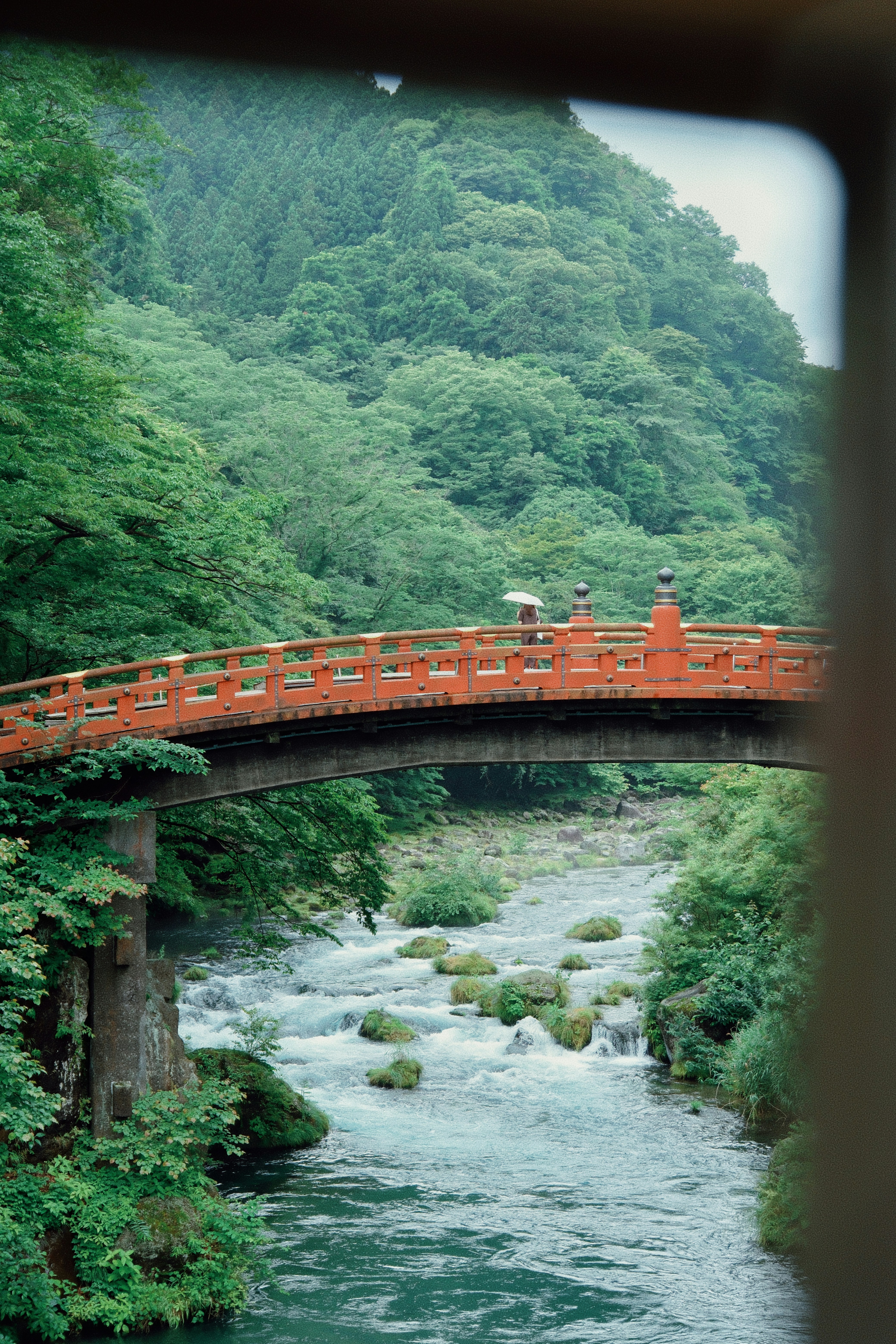 Crimson Arch Over River: A Quiet Moment on a Japanese-Style Bridge