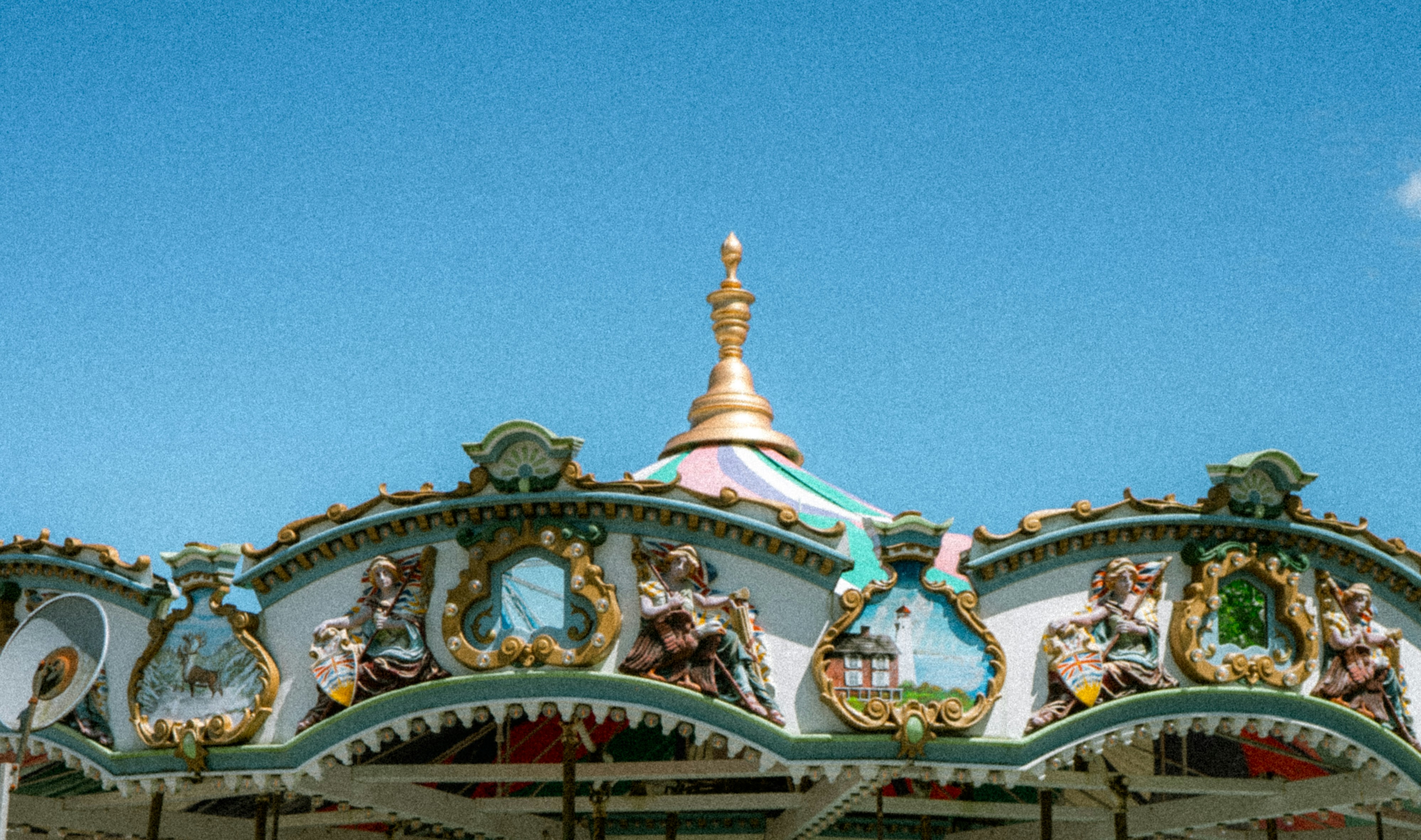 Ornate Carousel Crest Framed Against a Clear Sky