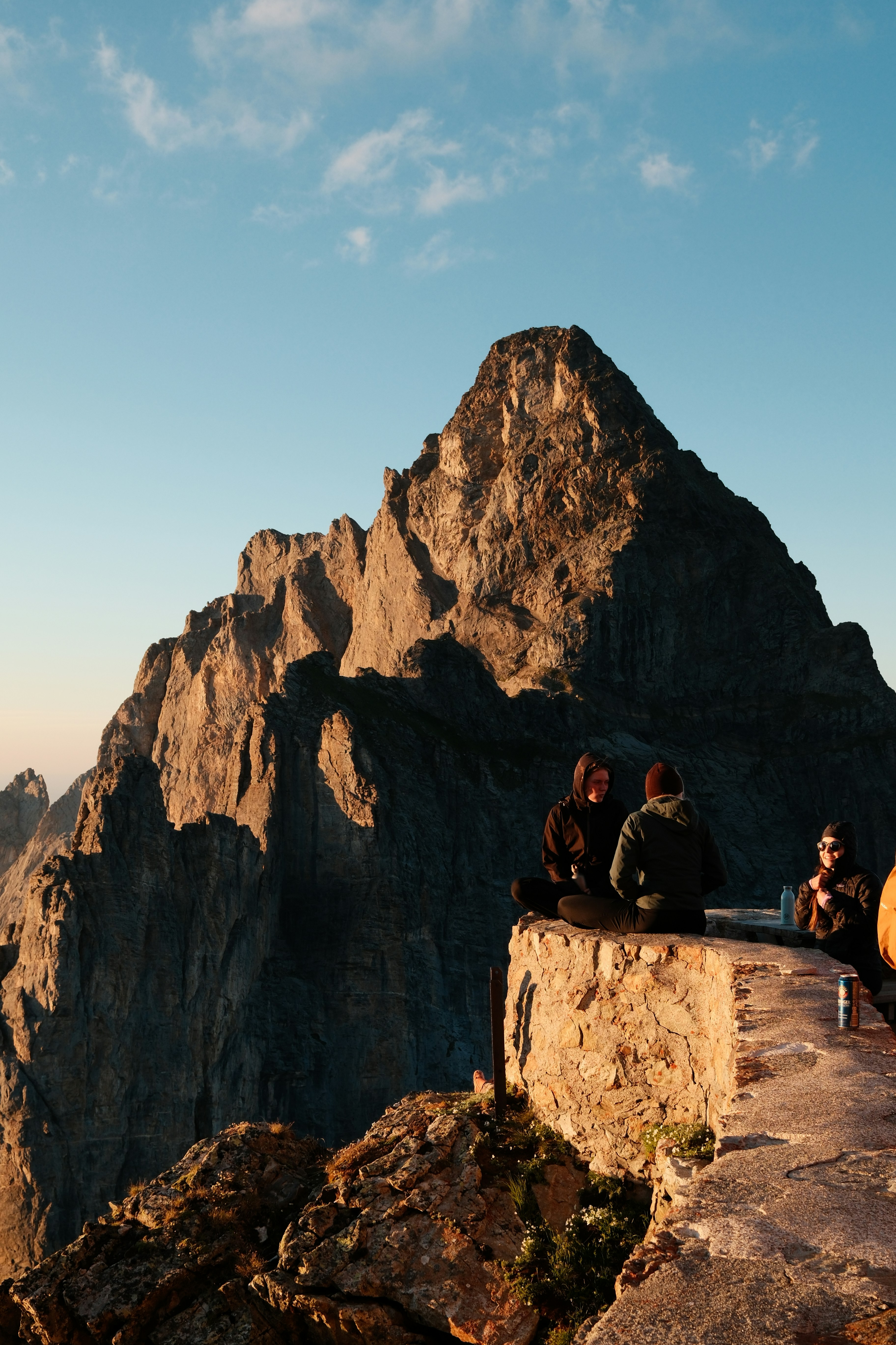 Sunset Summit: Friends Chat on the Perimeter of a Clifftop