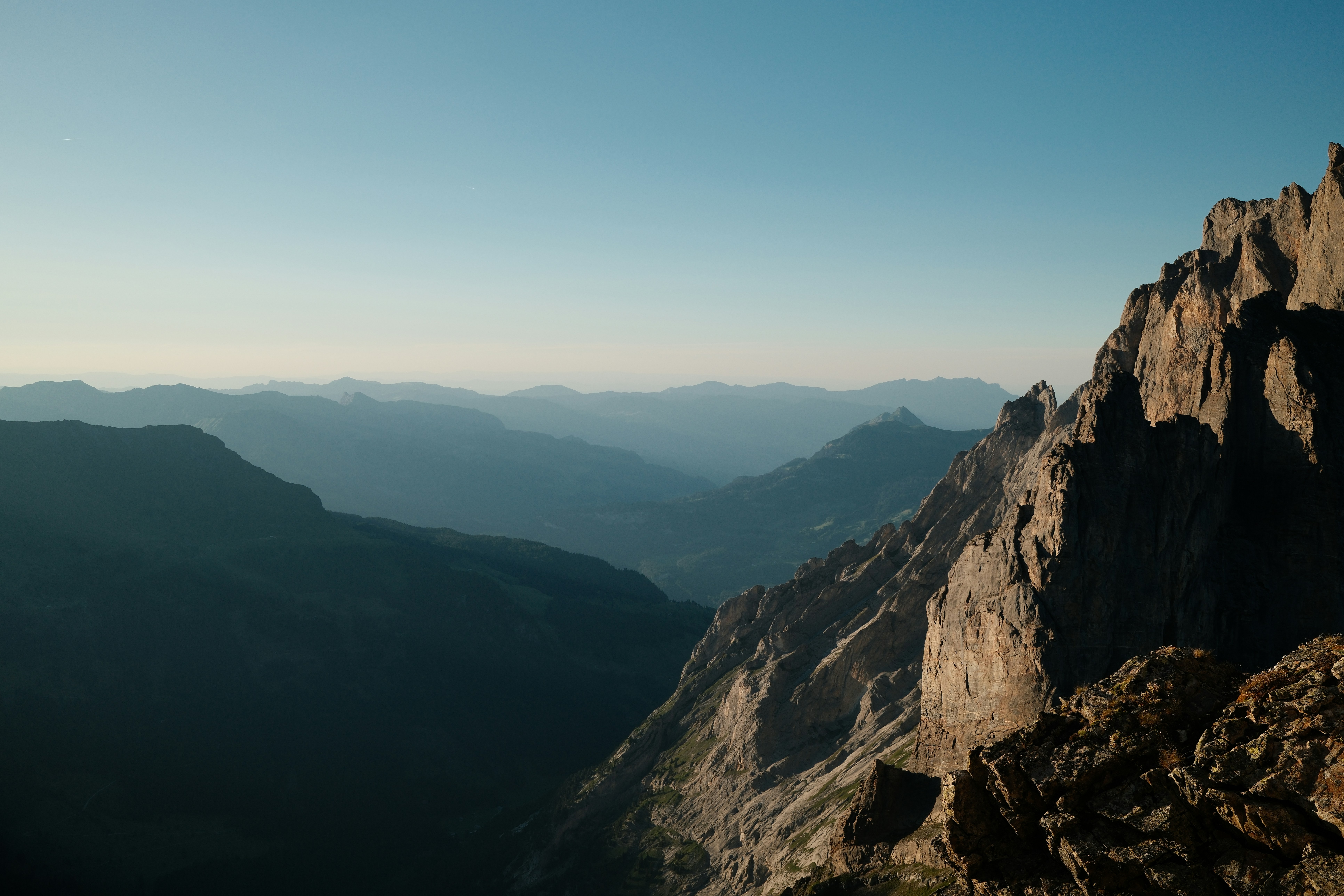 Edge of the World: Sunlit Peaks over a Quiet Valley