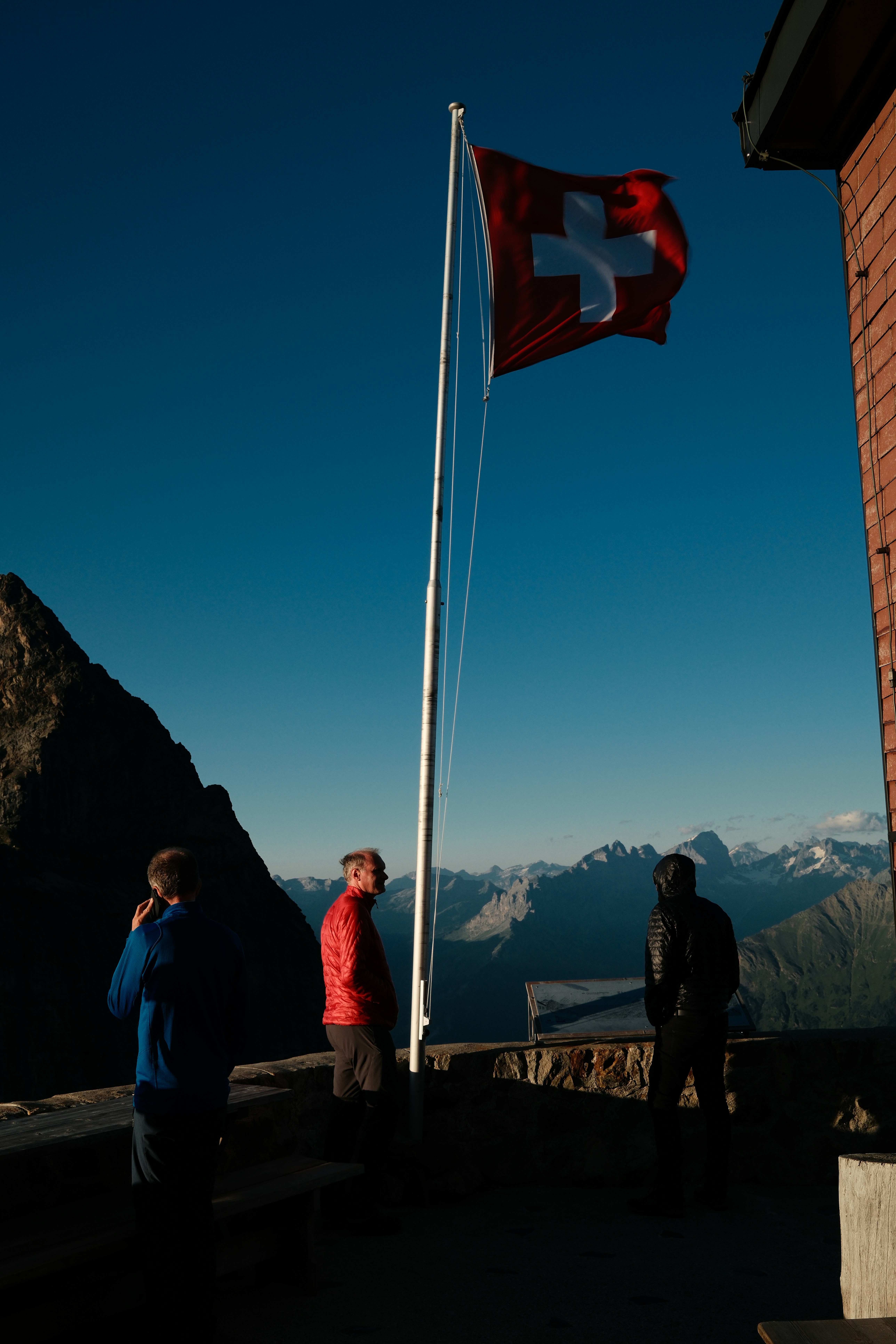 Flag Overlook: Swiss Flag Flap Above the Mountain Vista