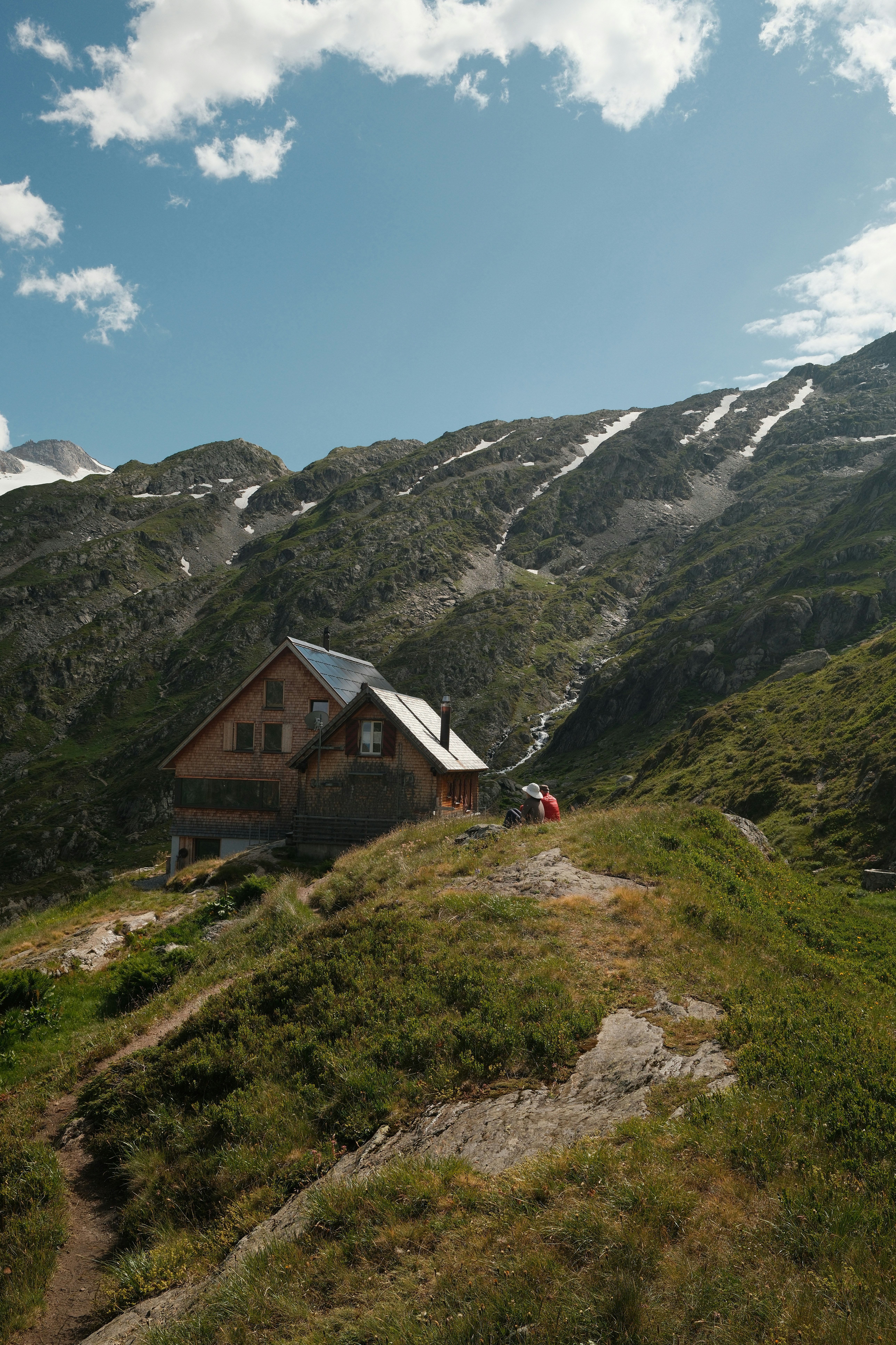 Alpine Refuge Beneath Snow-veiled Ridge