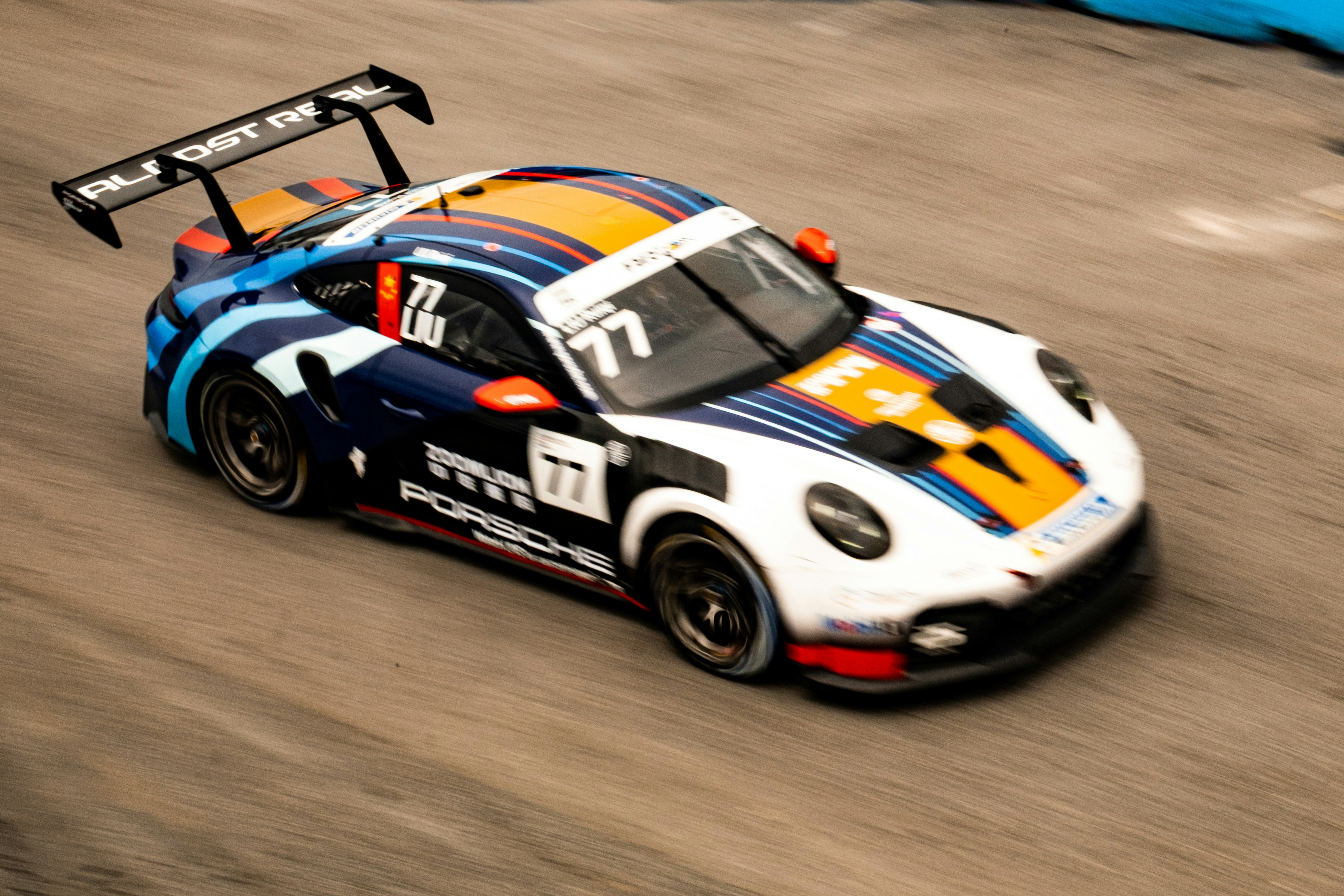 Chromatic Blur: A Race-Painted Porsche Slashes Through the Dust