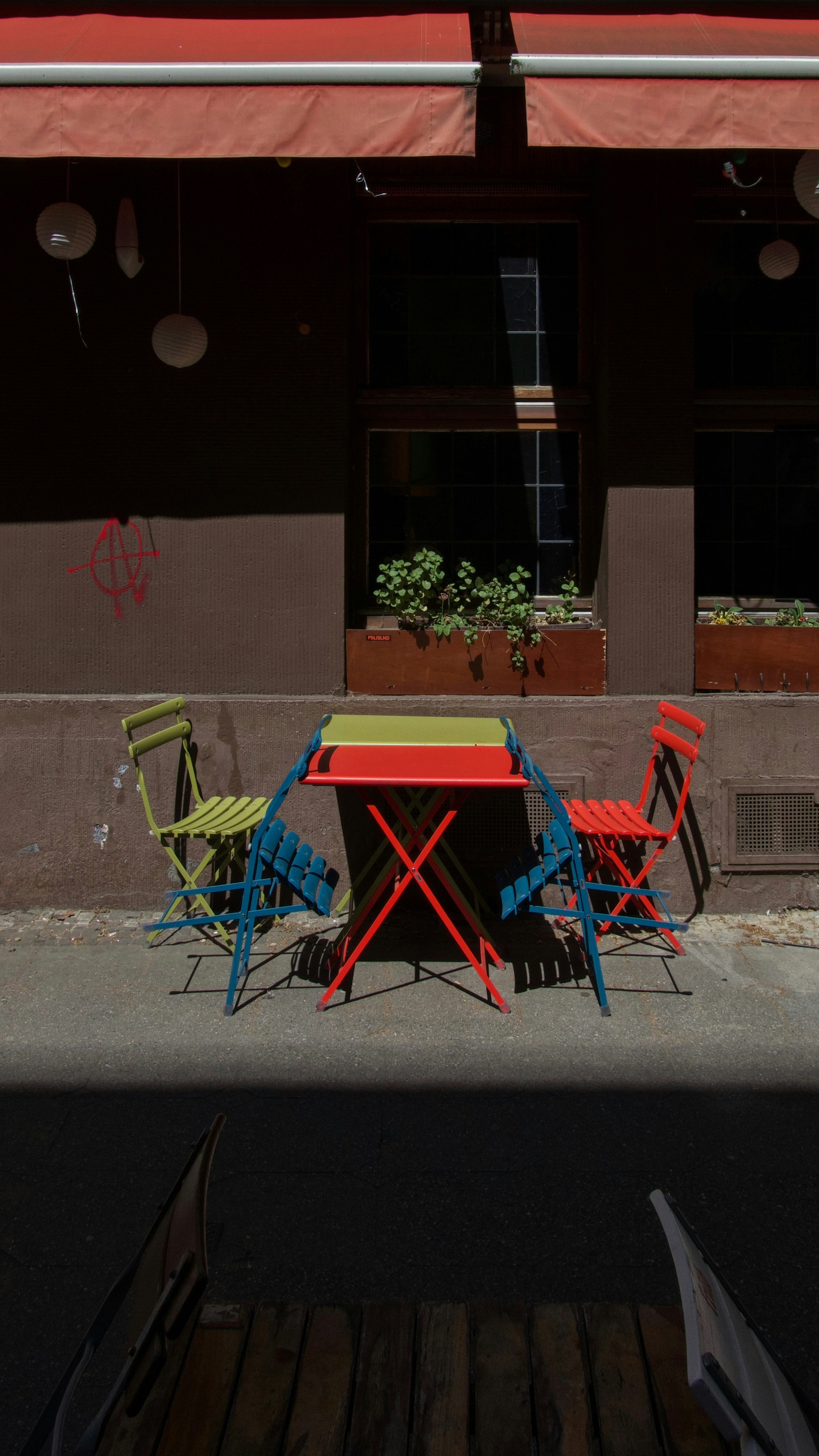 Bright Bistro Bistroset: A Trio of Colorful Chairs Framing a Central Table