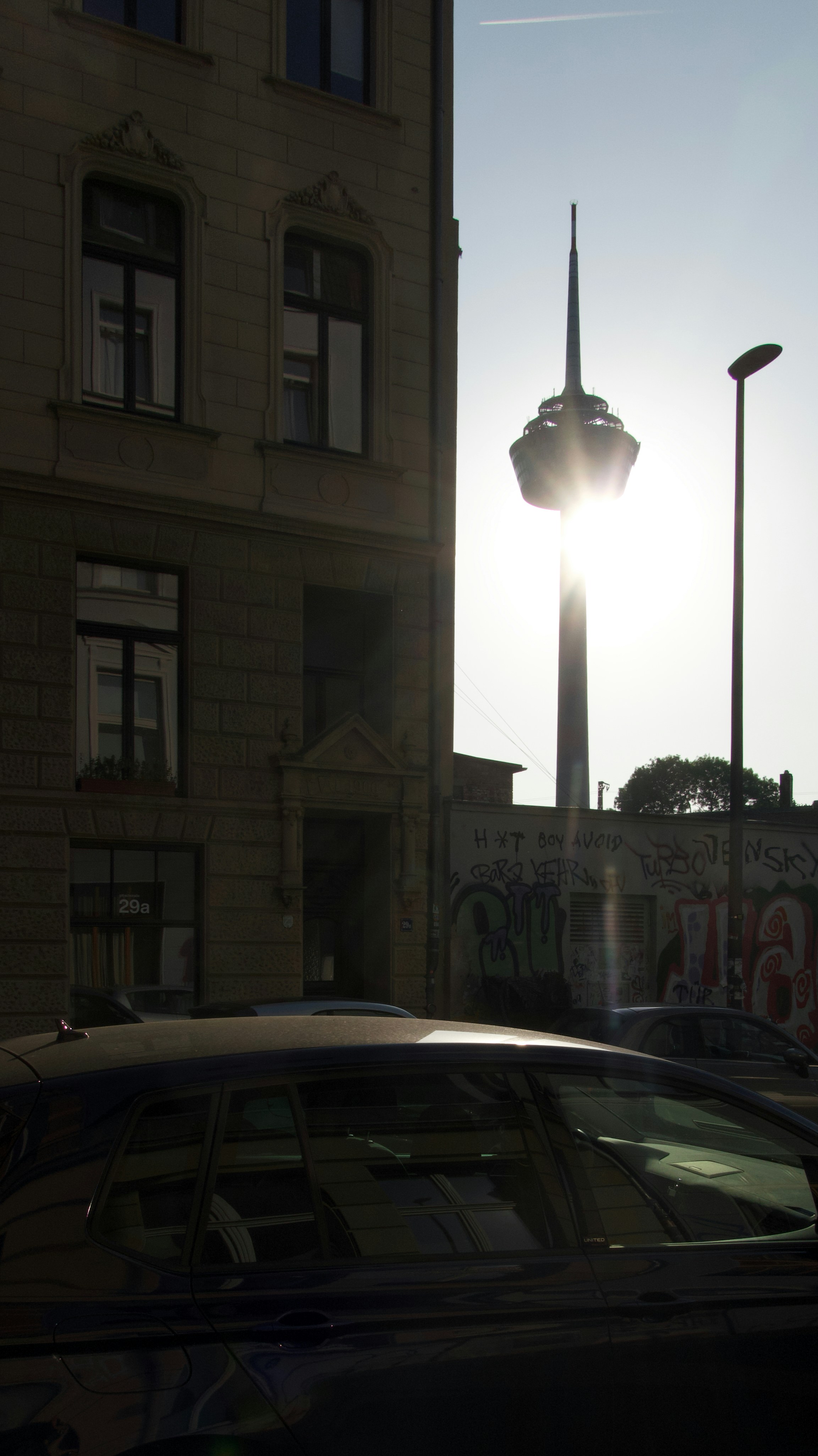 Sunlit Tower Behind a Curbside Cityscape