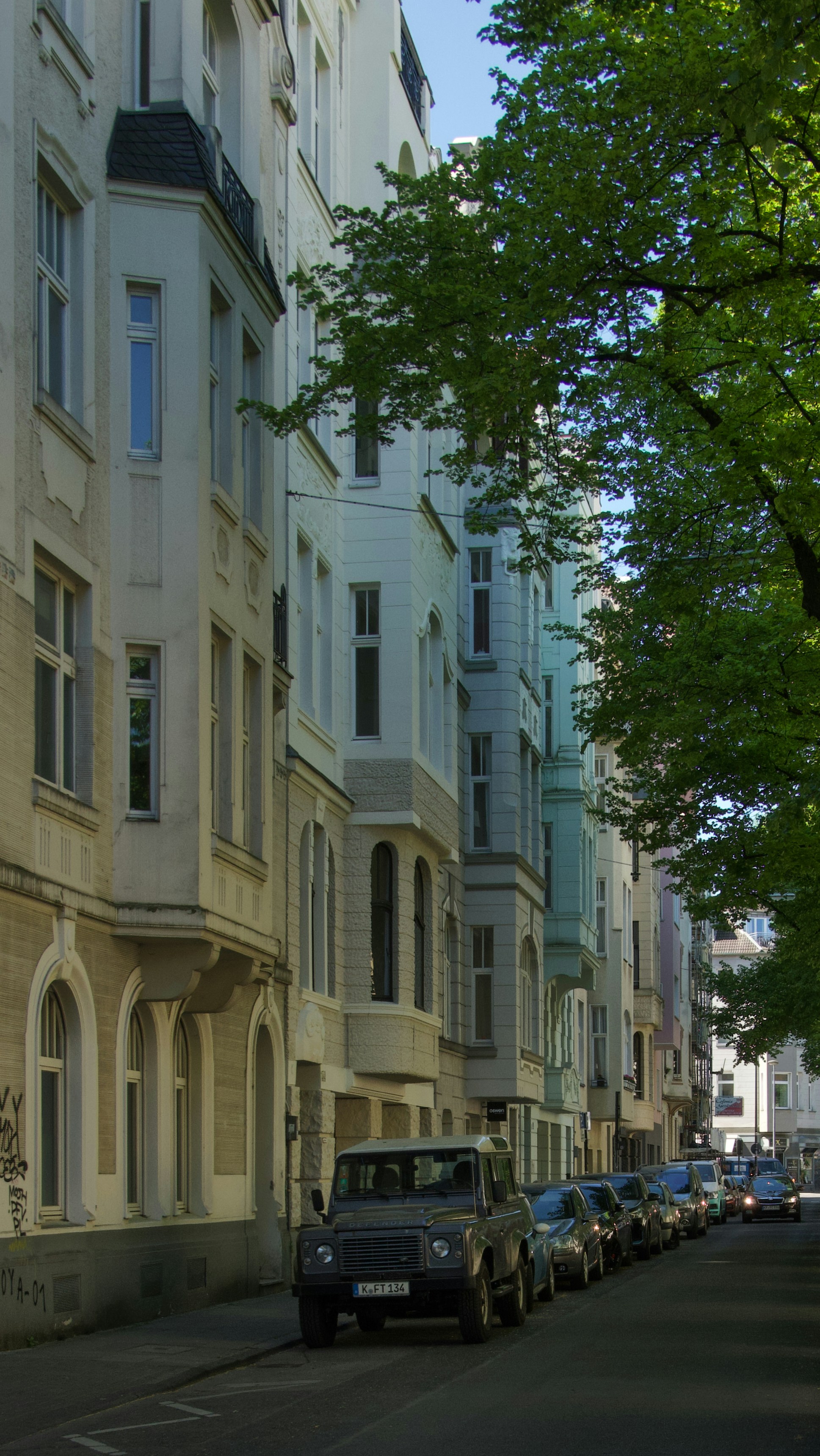 Colorful Riverside Street: Row of Townhouses and a Front-Row Car Line