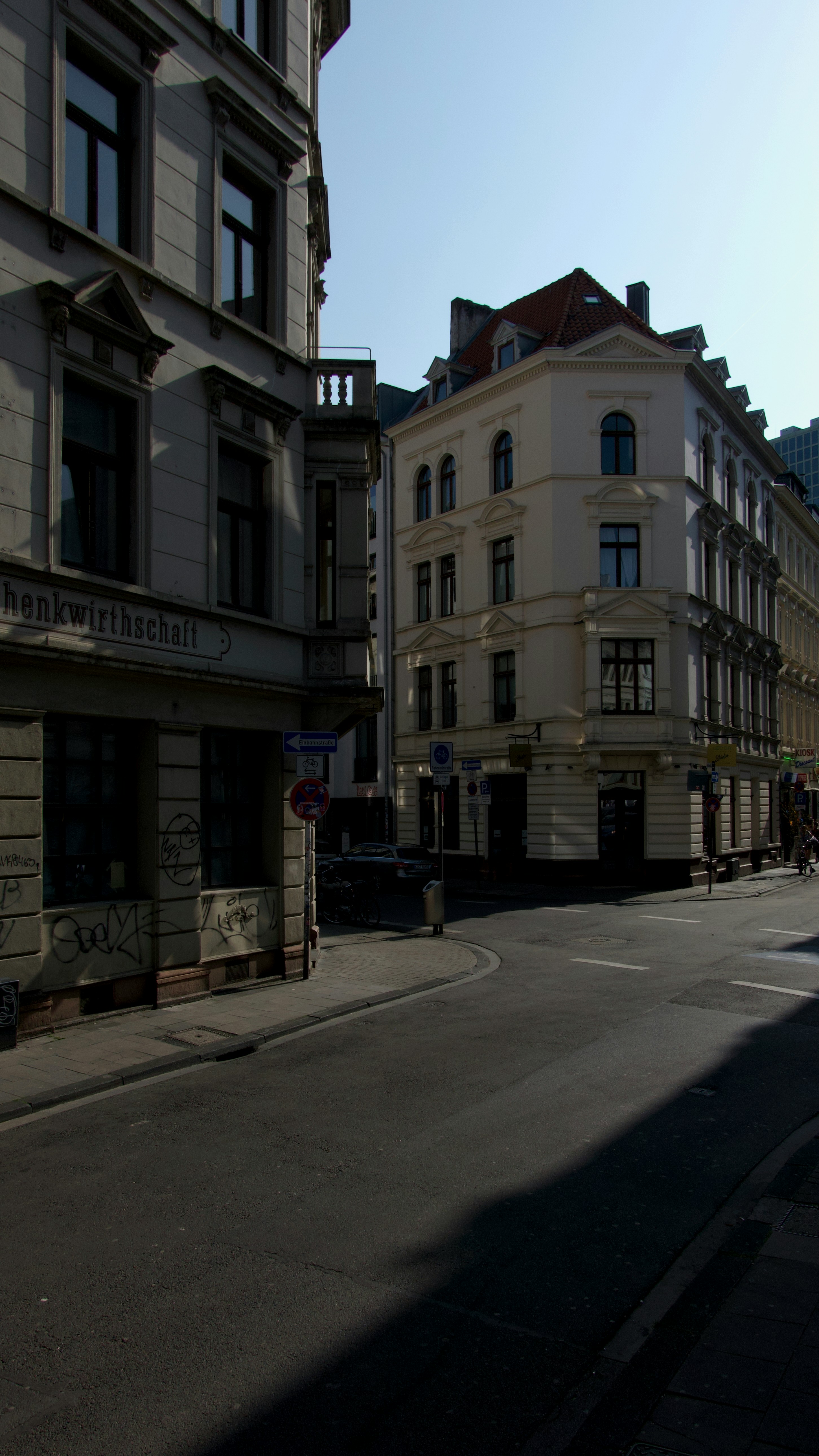 Sunlit Corner Balcony over a Quiet European Street