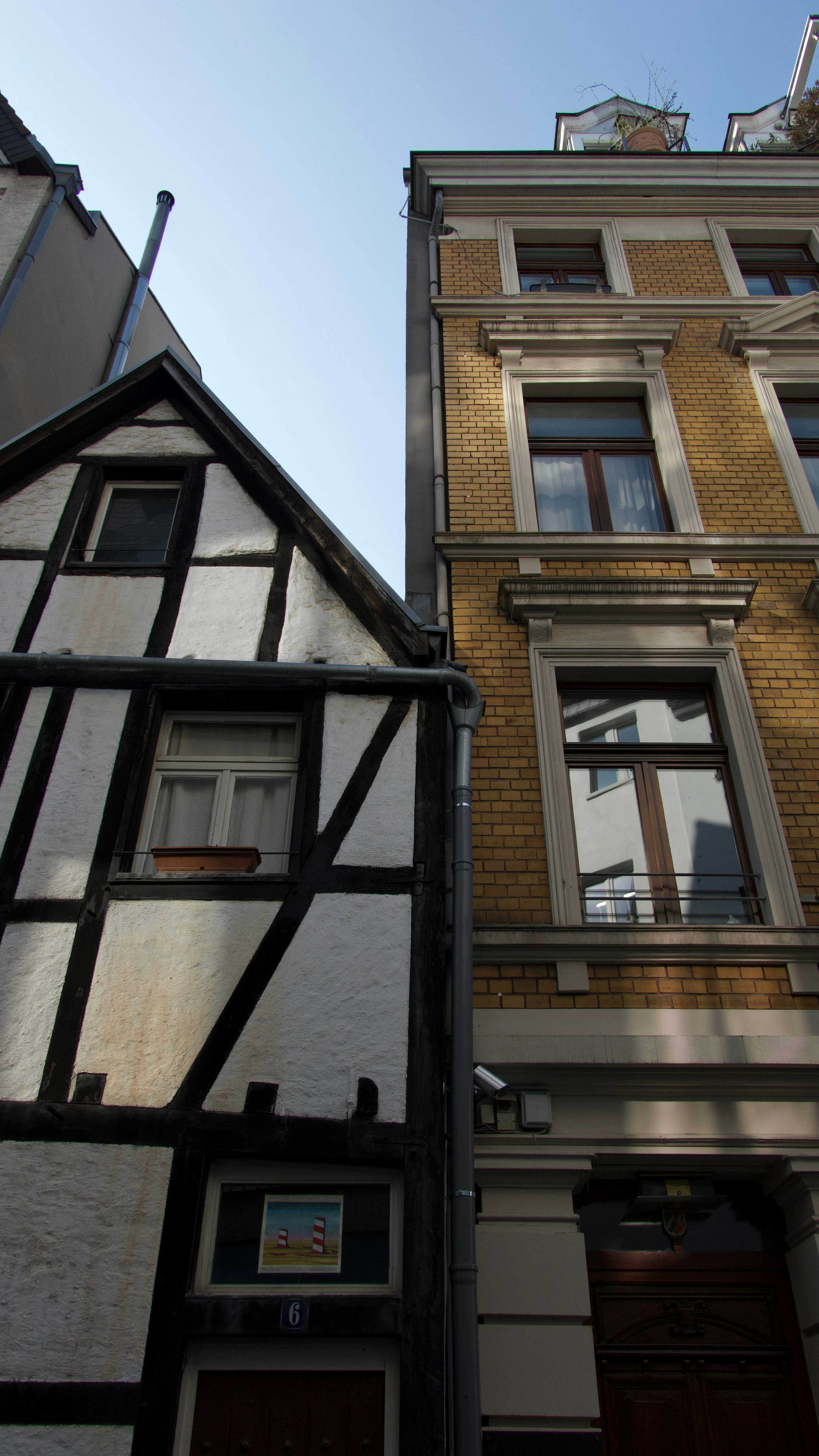 Historic Facades Converge: A Street Corner Between Timber and Brick