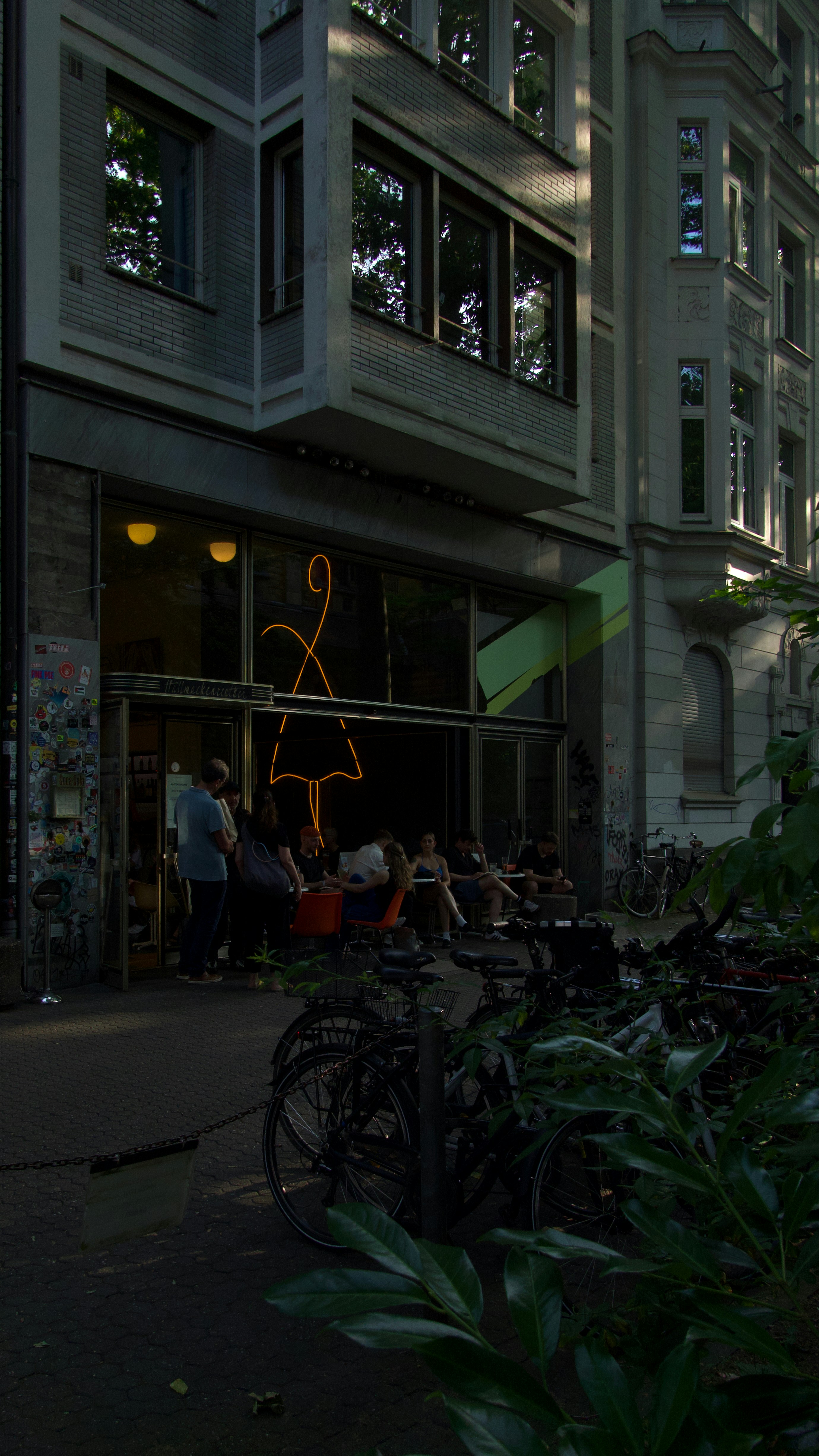 Evening Café Glow Under Urban Facades