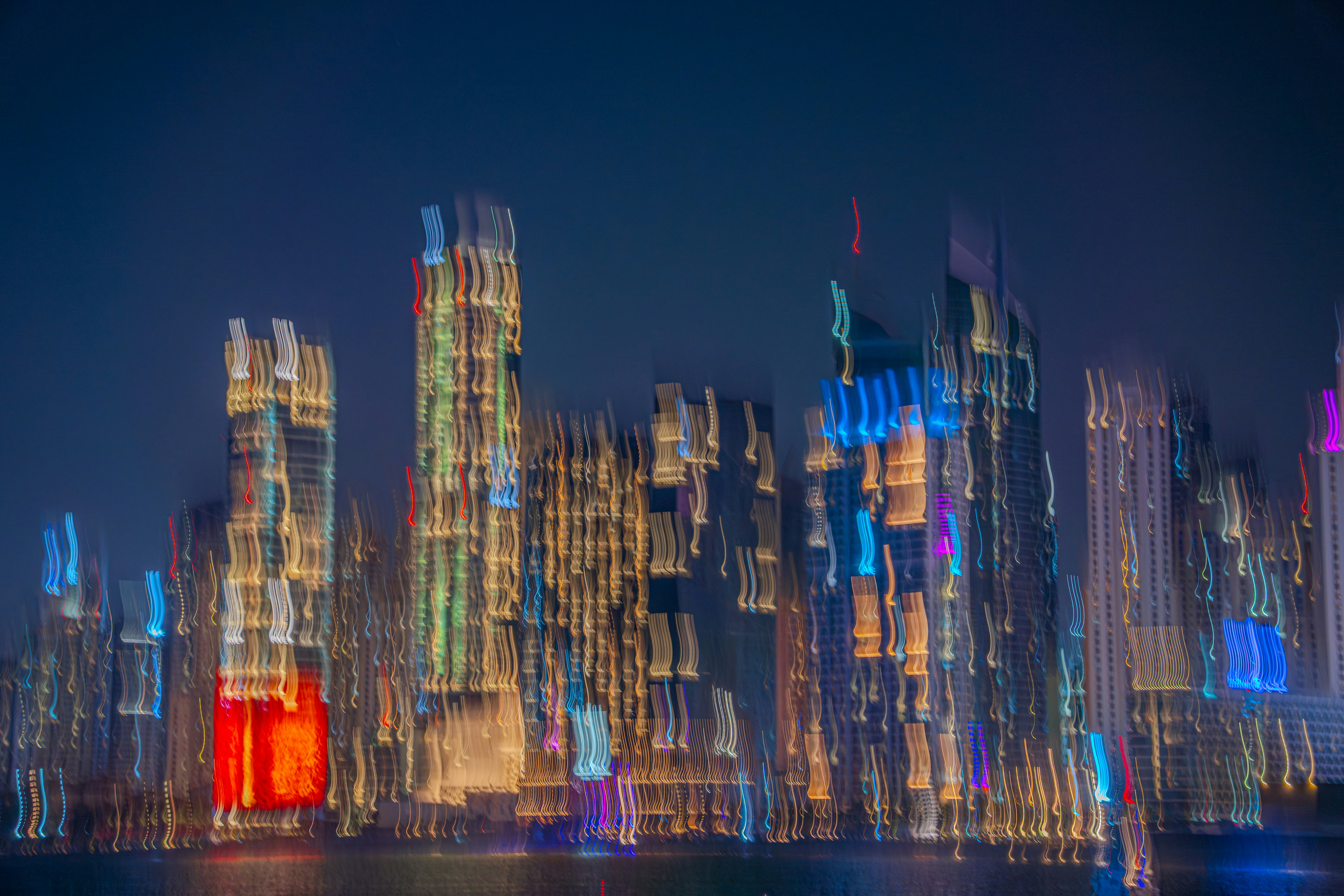 City Lights in Motion: Neon Blur Over the Waterfront
