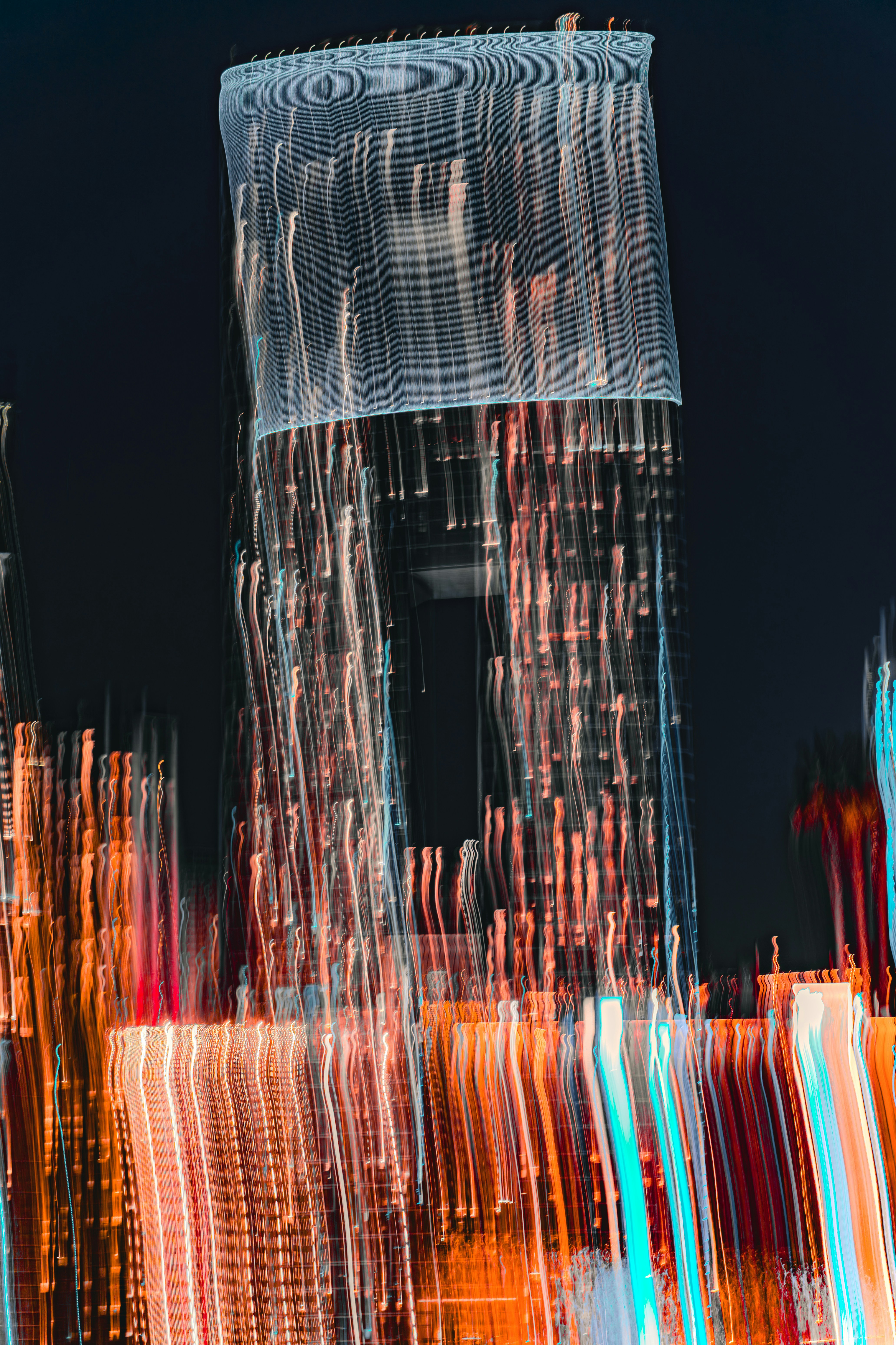 Night Pulse: Neon Streaks Over a Skyscraper