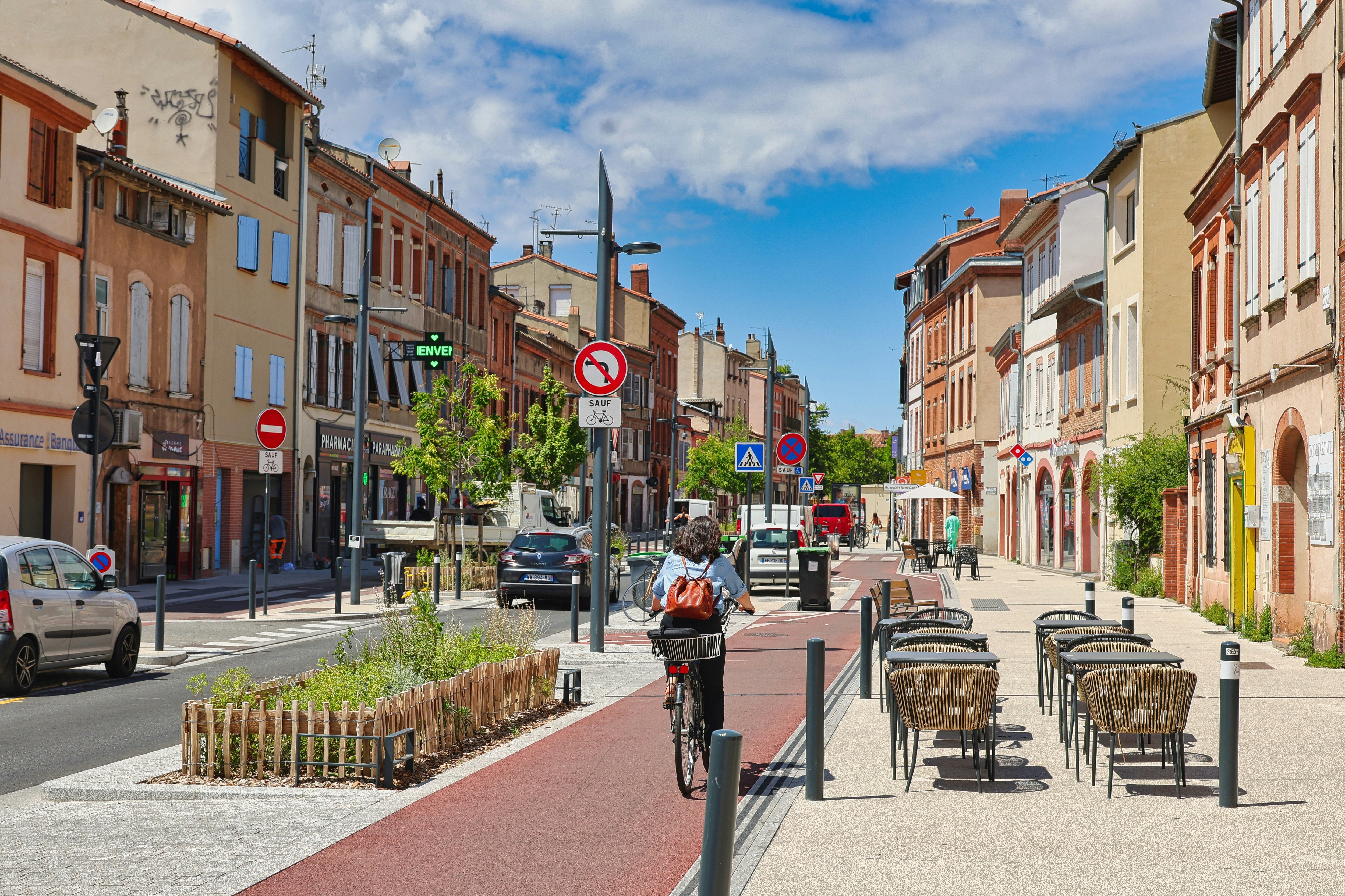 Pedestrian Street Scene with Cyclist and Café Terrace
