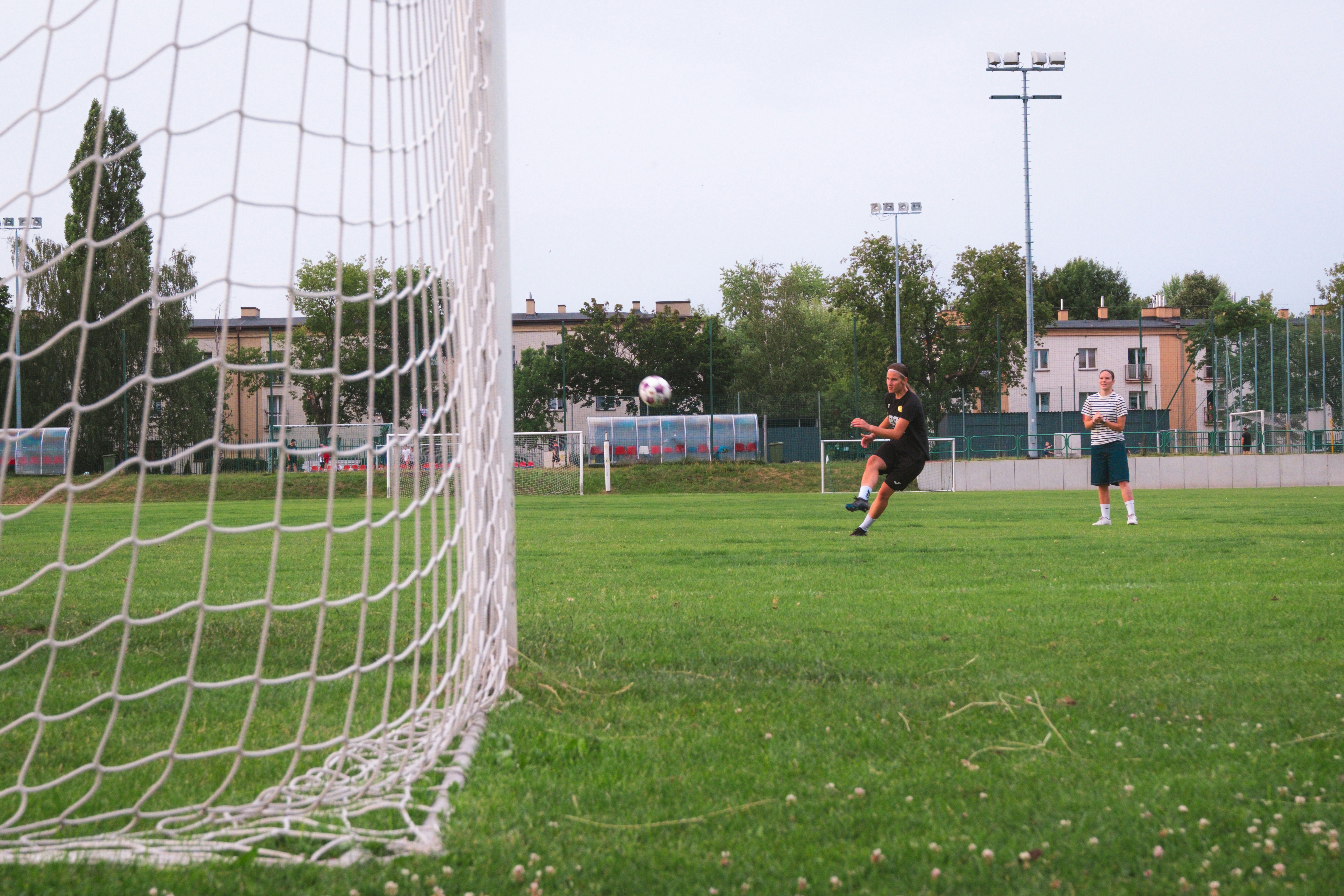 Penalty Moment at the Park: A Striker's Shot Near the Net
