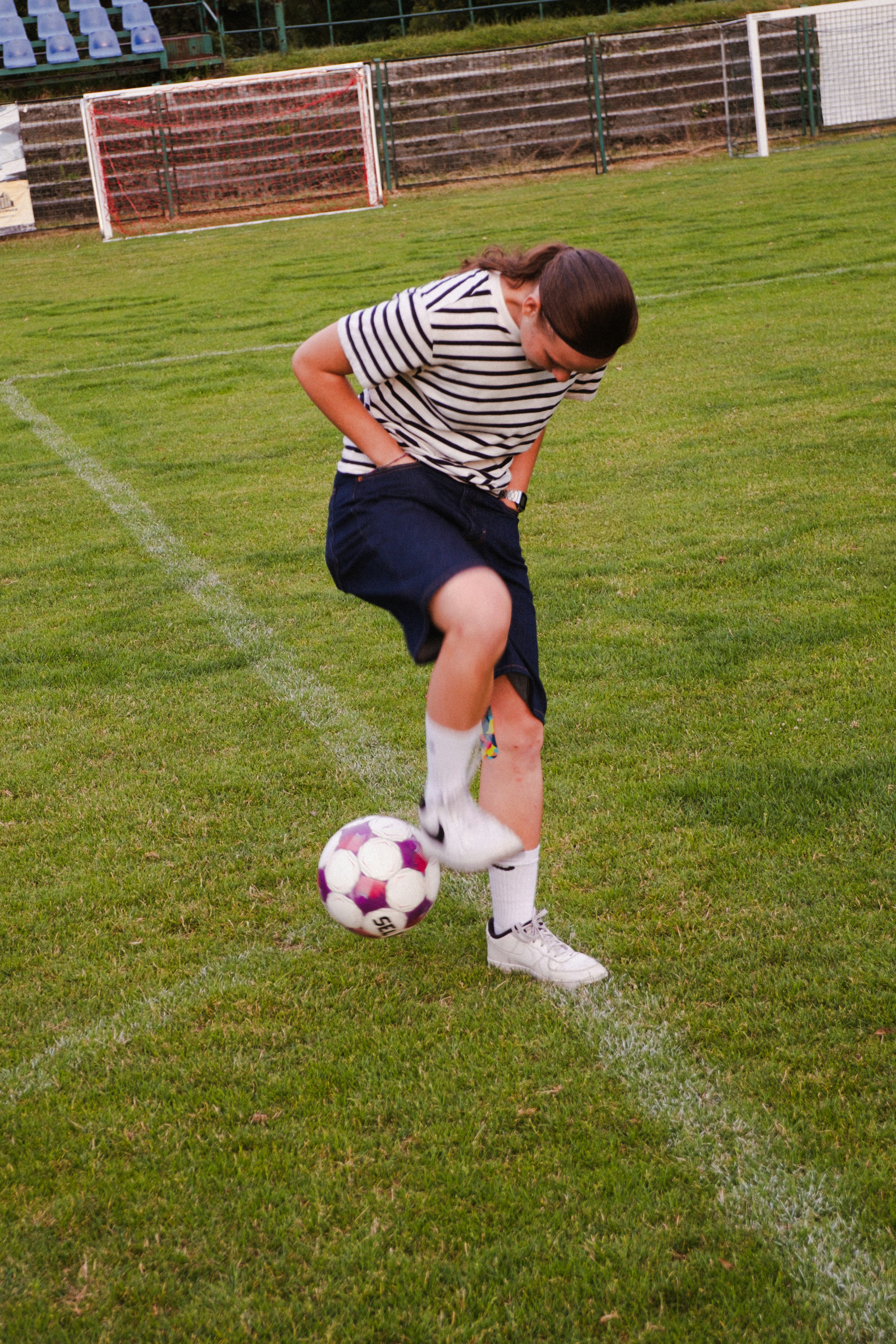Mid-kick Focus: A Youth Soccer Moment on Grass
