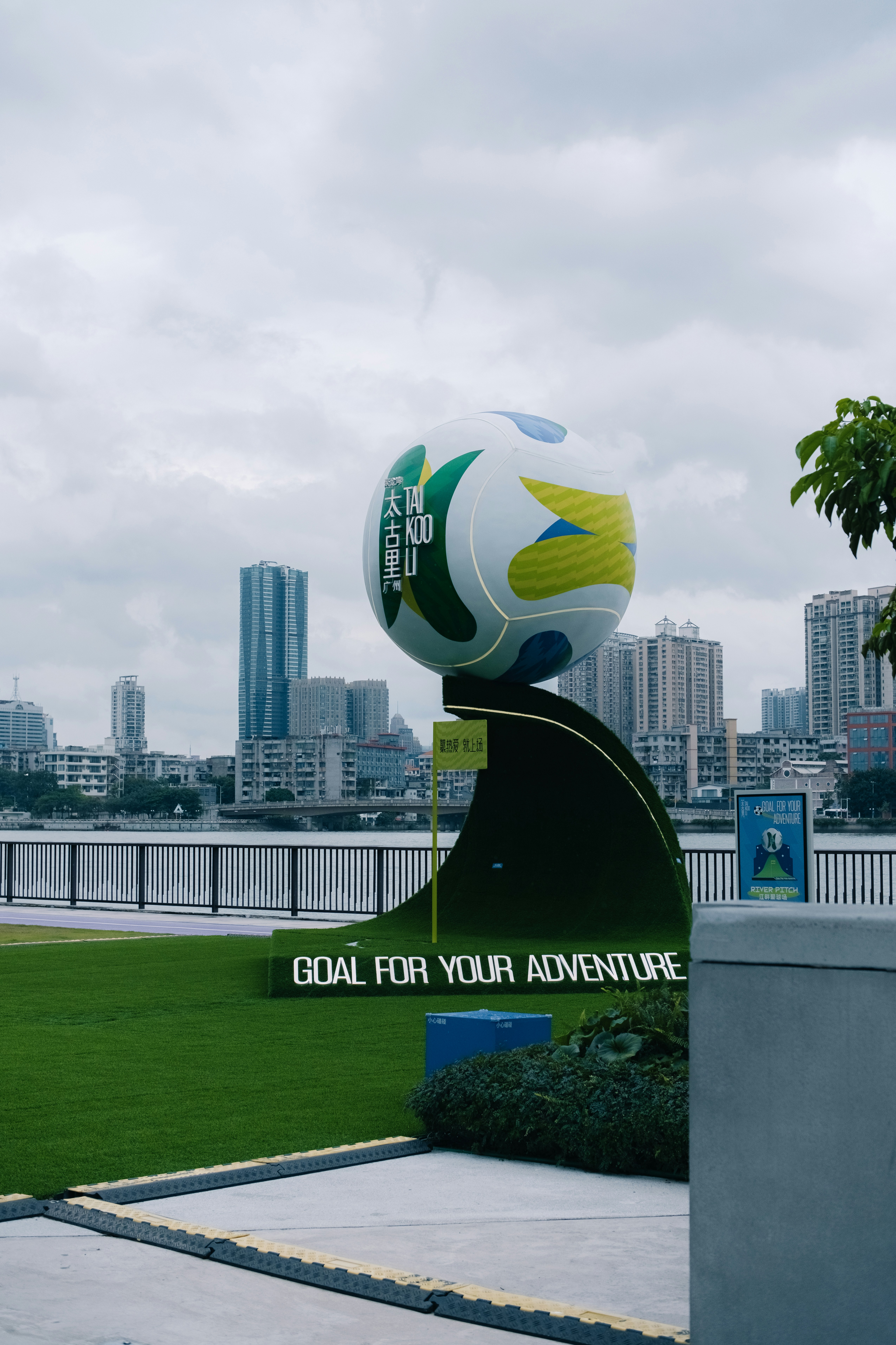 Ballooned Ambition: A Floating Globe Above a City Park