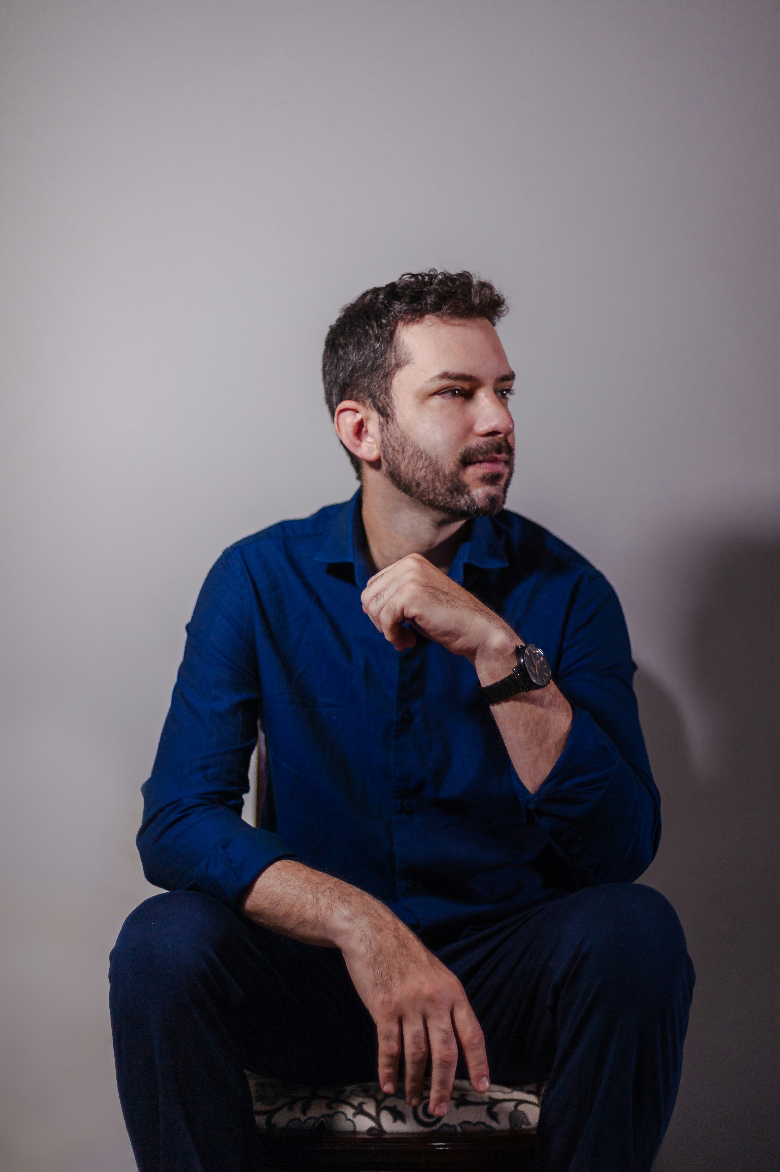Blue Shirt, Quiet Gaze: A Studio Portrait in Subtle Light
