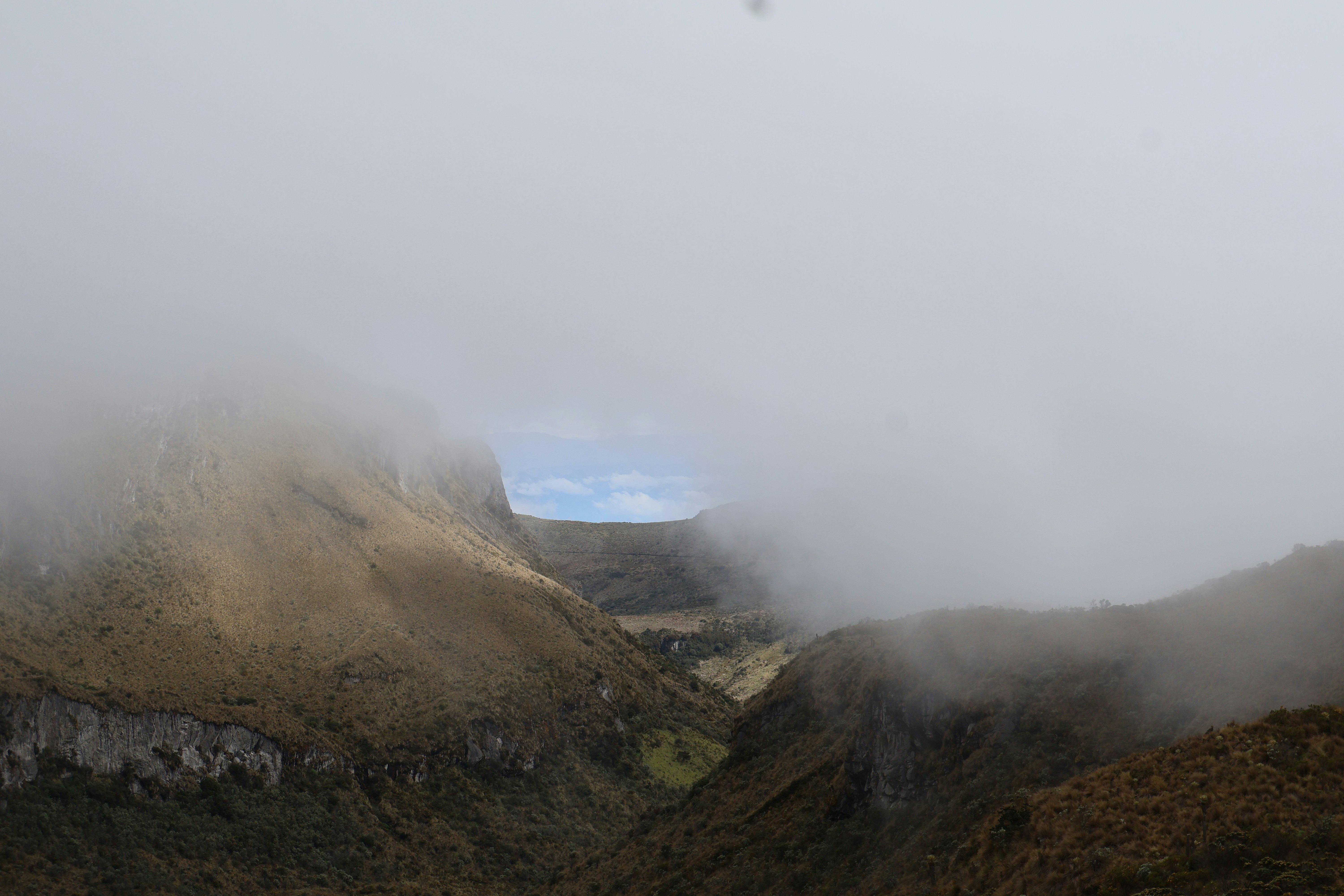 A Mountain Pass Emerging Through Low Clouds