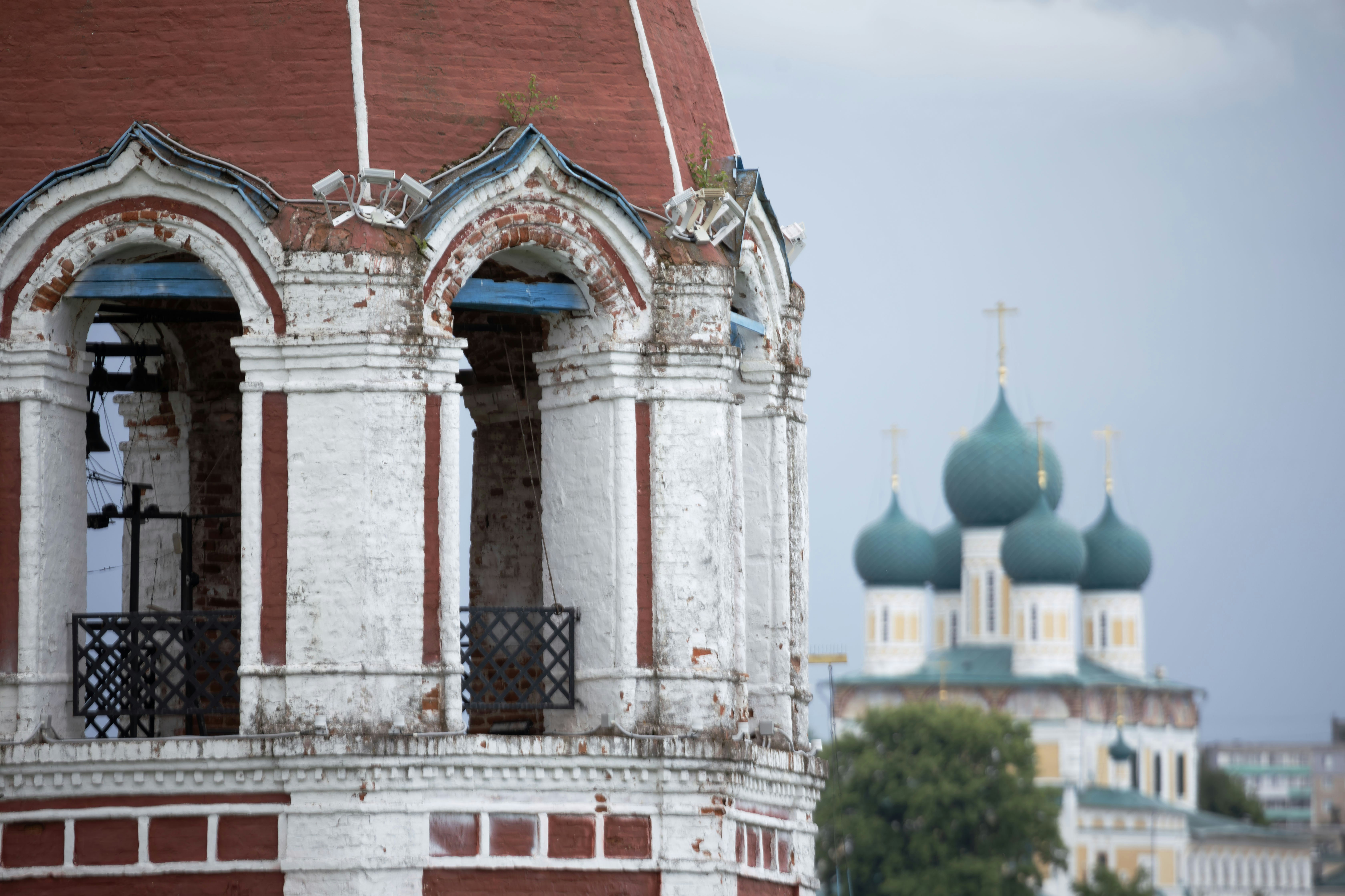 Weathered Bell Tower with a Distant Onion-Domed Cathedral