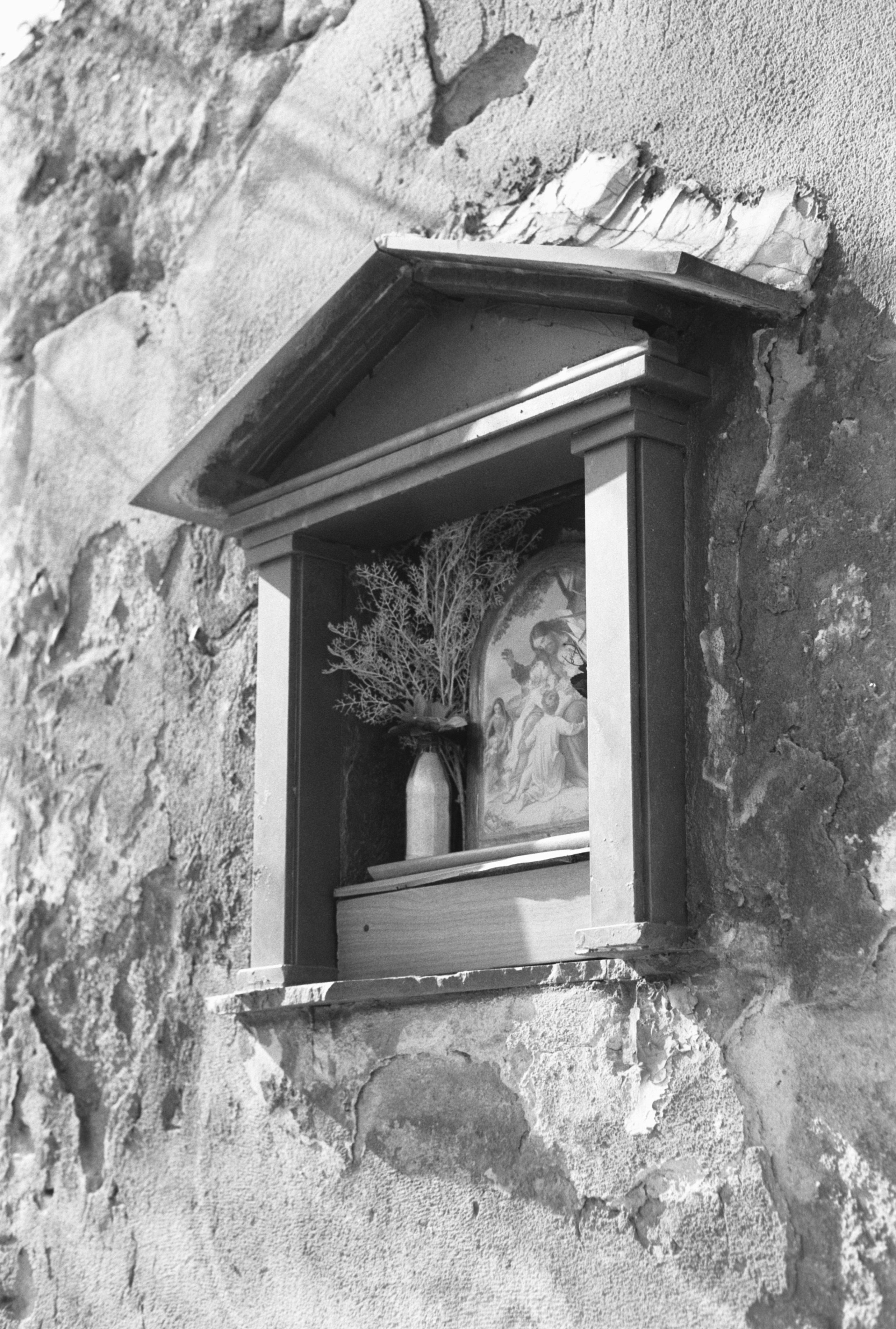 Stone Shrine Recess: A Quiet Altar Framed in Plaster and Shadow