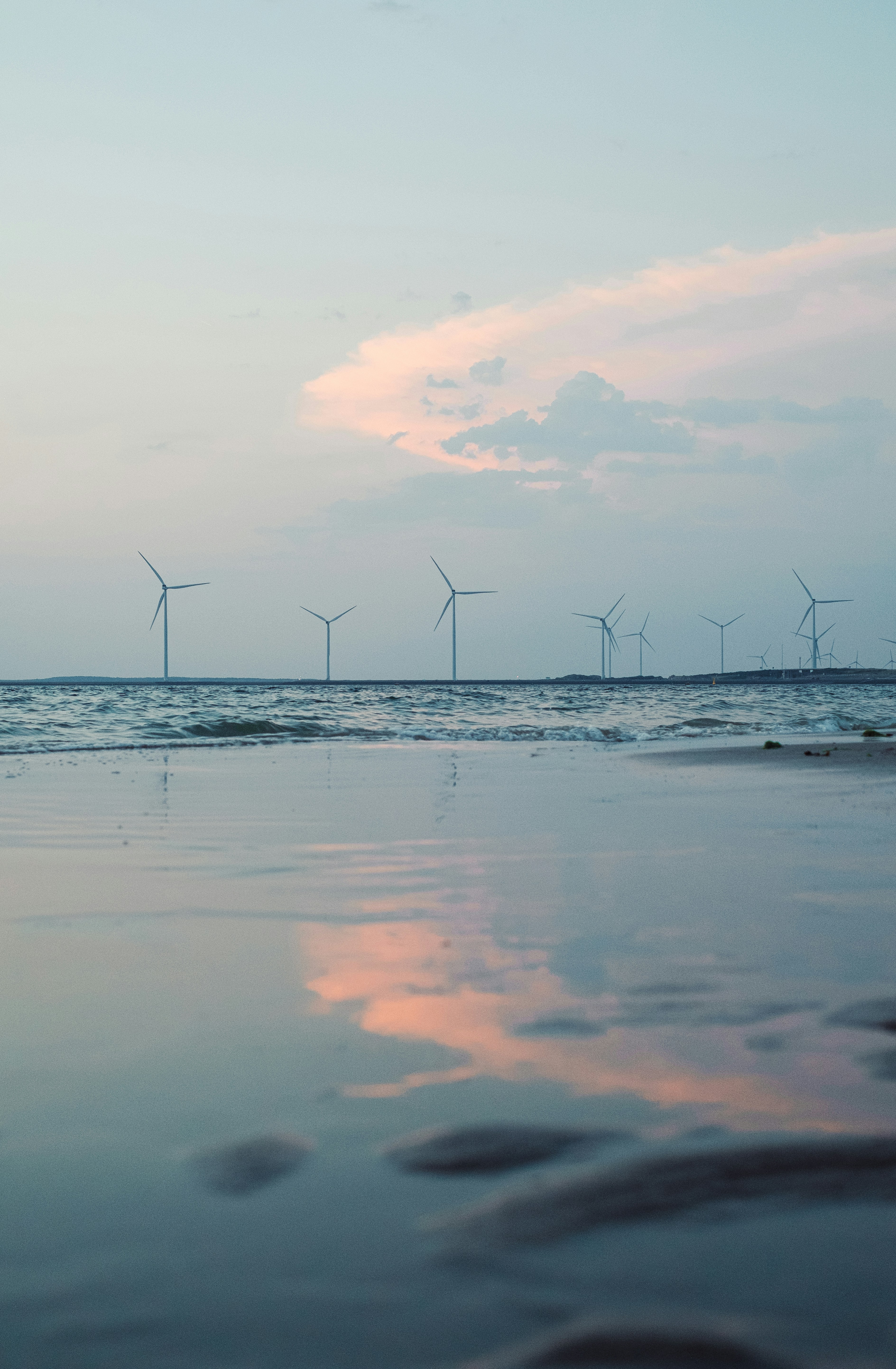 Coastal Windmills at Dusk: A Quiet Tidal Stand Against the Horizon