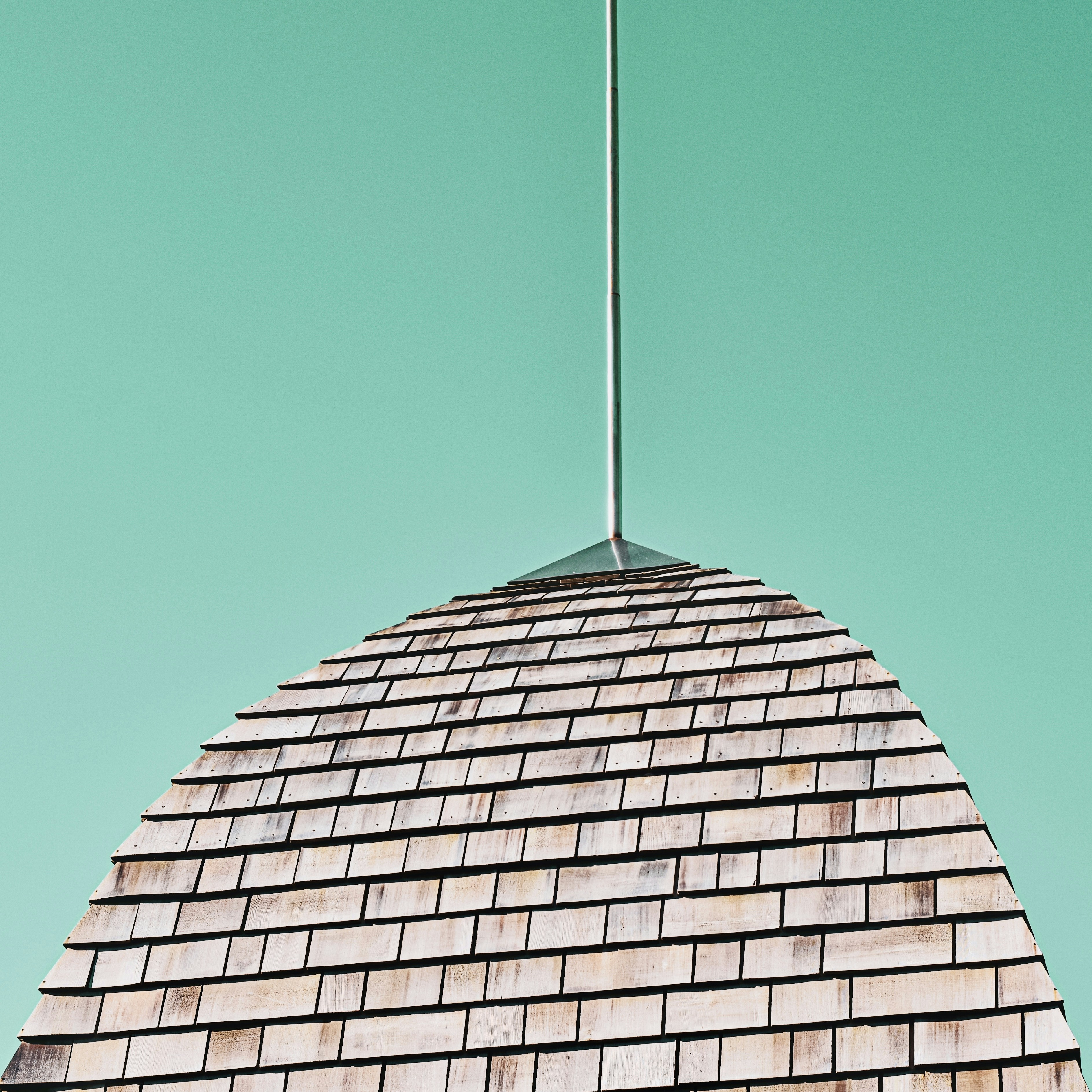 Conical Wooden Roof Reaching Toward a Mint Sky
