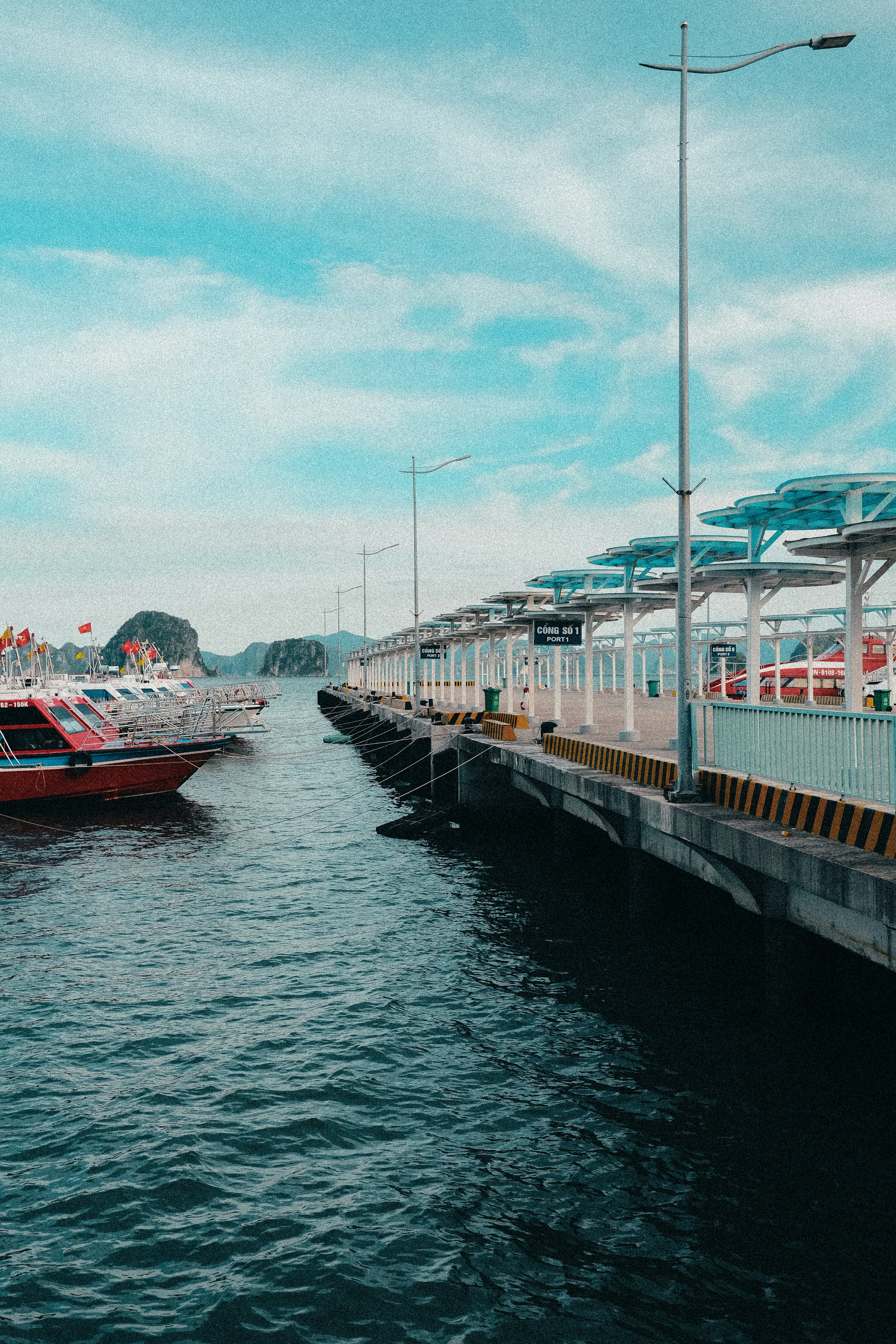 Harbor Line at Dusk: Boats, Shoreline, and Morning Sky