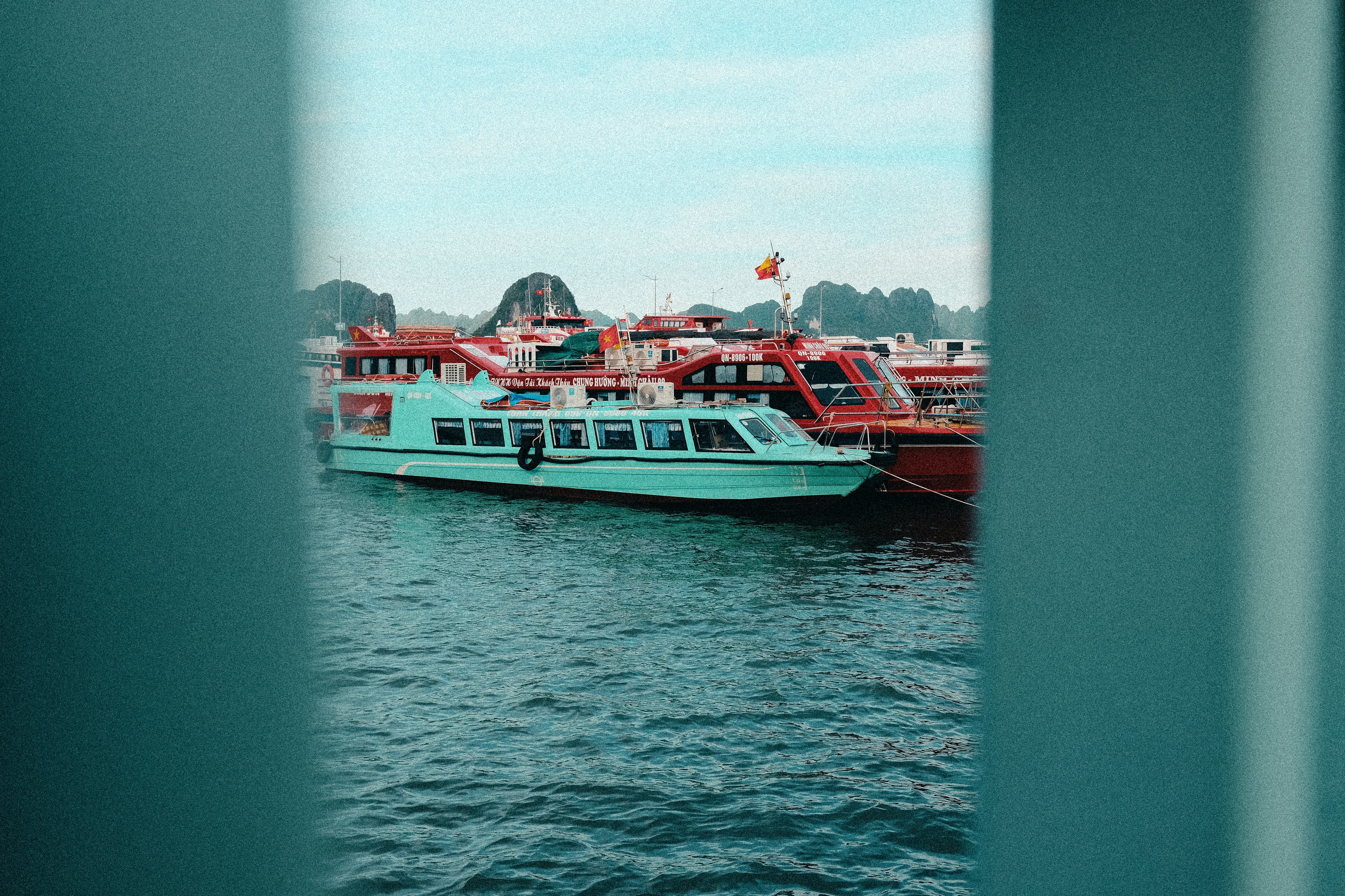 Teal Boat Row in a Framed Harbor