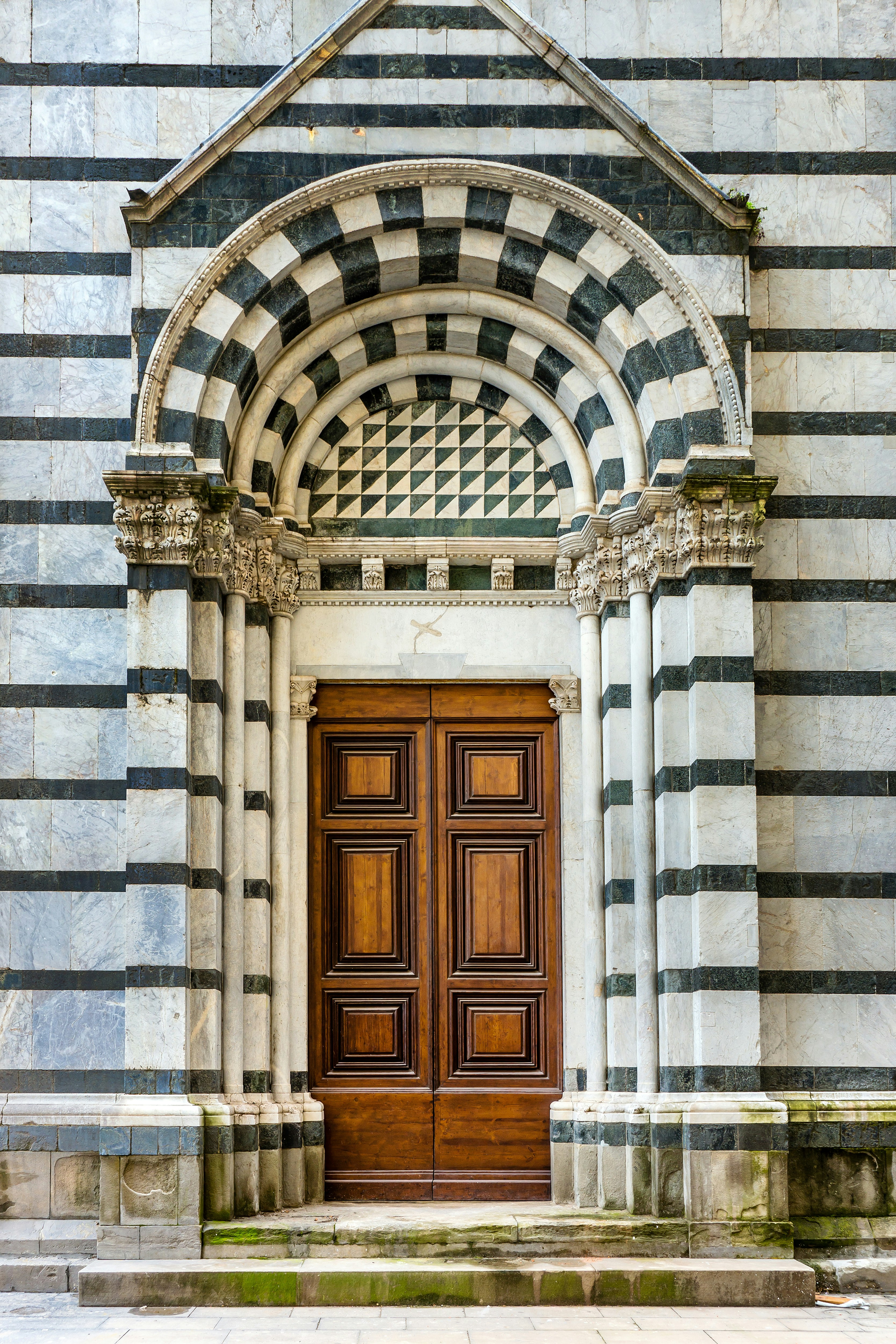The Striped Portal: A Carved Door Framed by Interlacing Arches