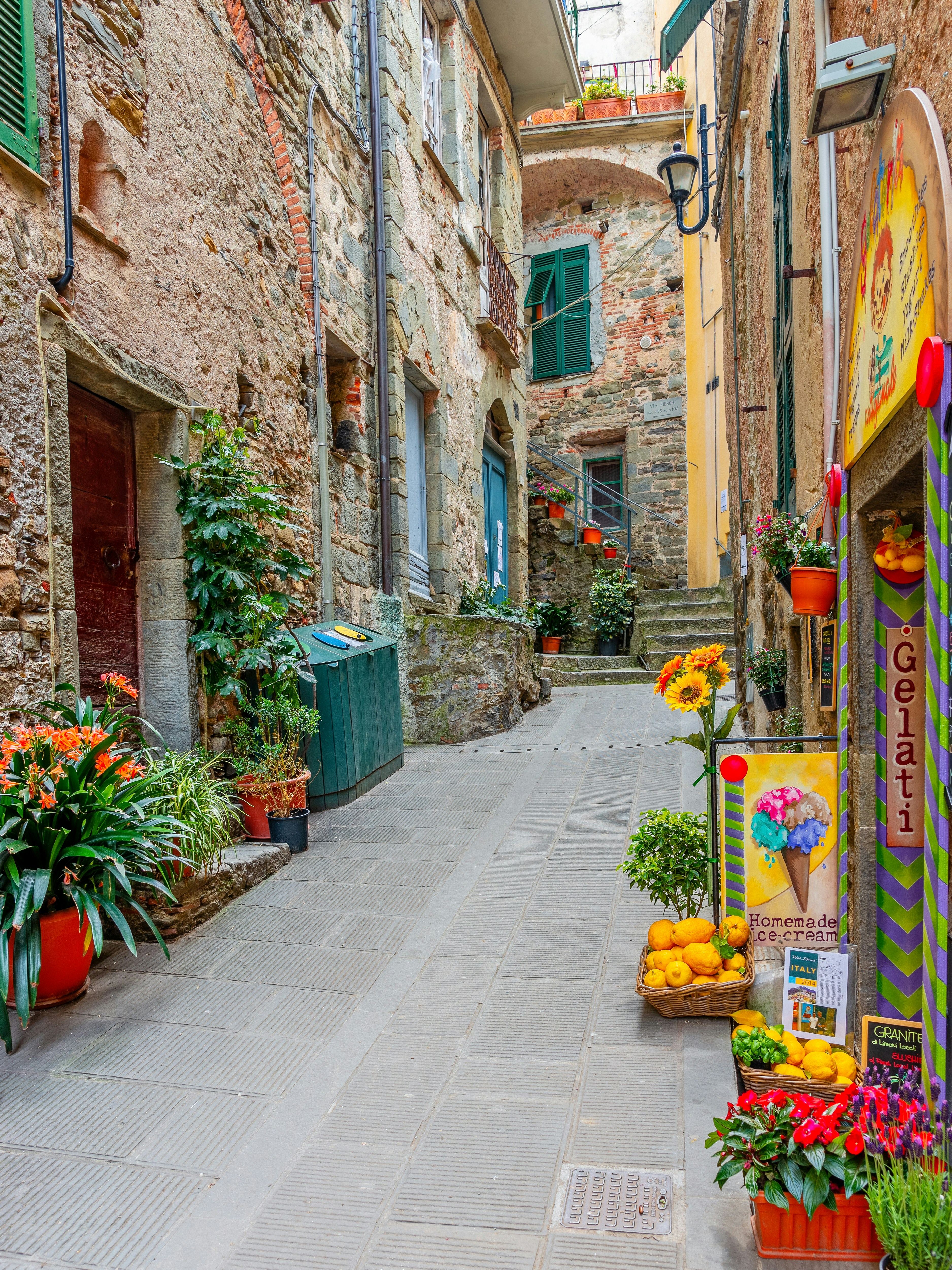 Sunlit Street Spice: A Colorful Italian Alley Near the Market