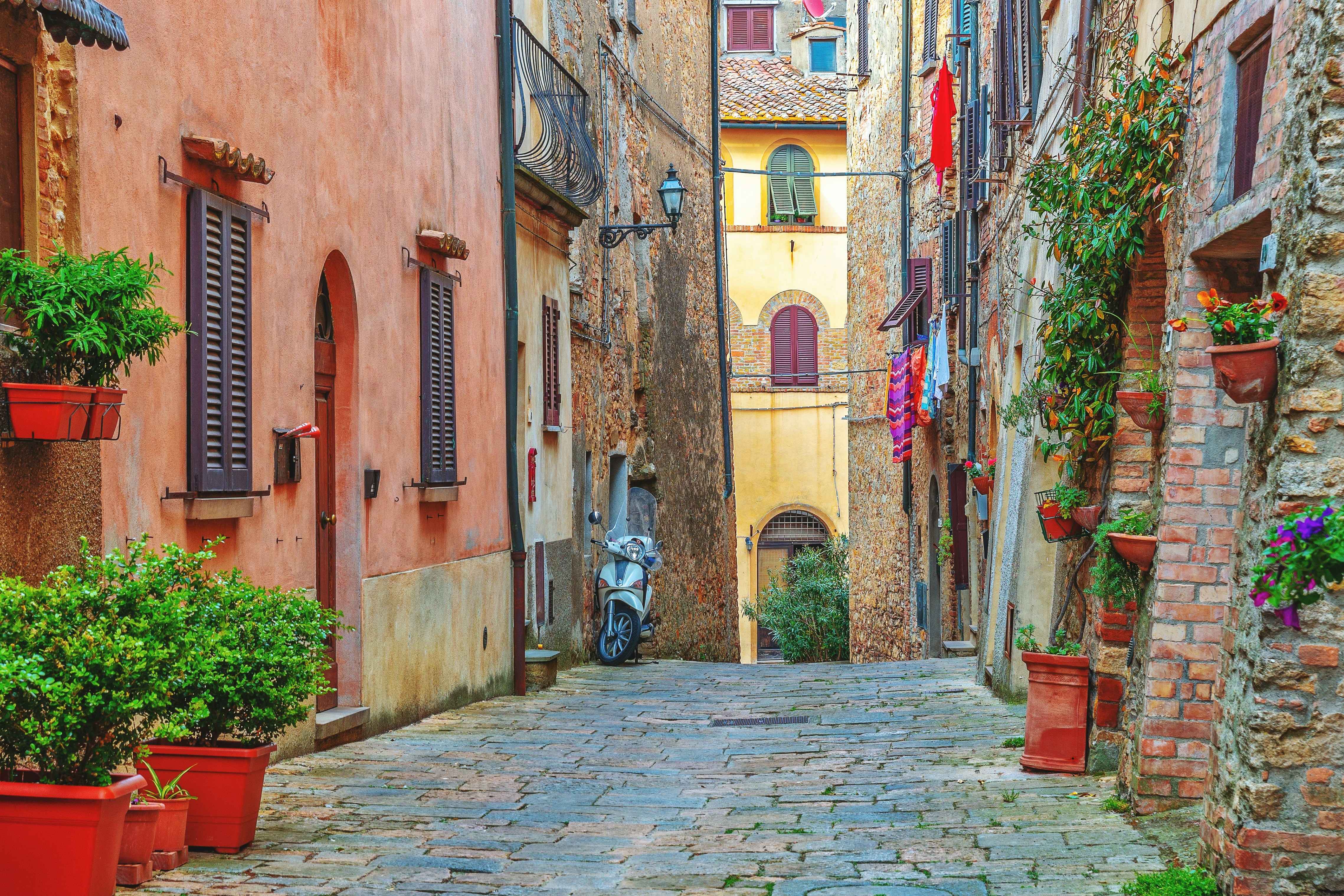 Stone-Cobbled Alleyway: A Quiet Corridor Between Warm Facades
