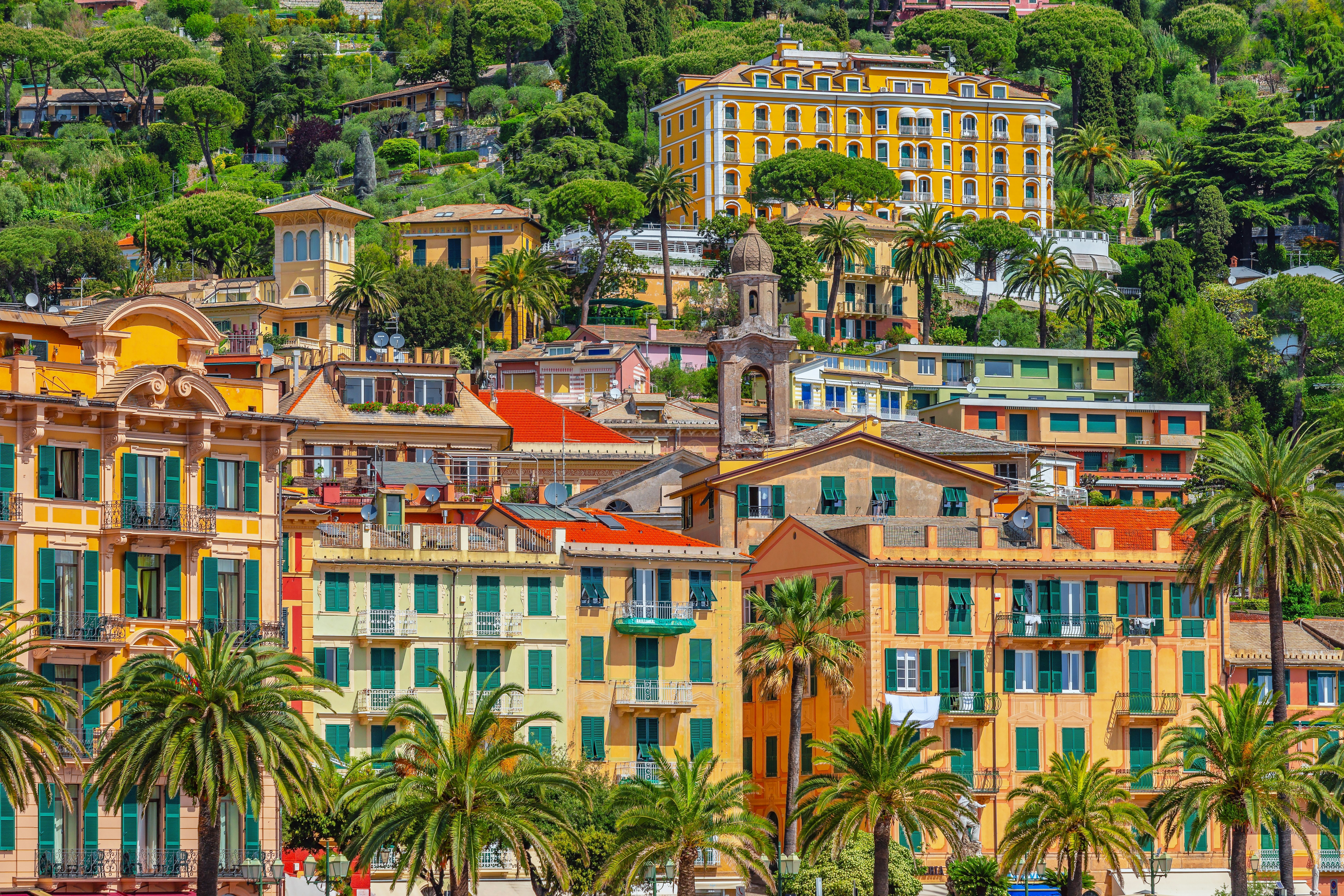 Vibrant Limestone Village Descends Through Palm-Studded Hillside